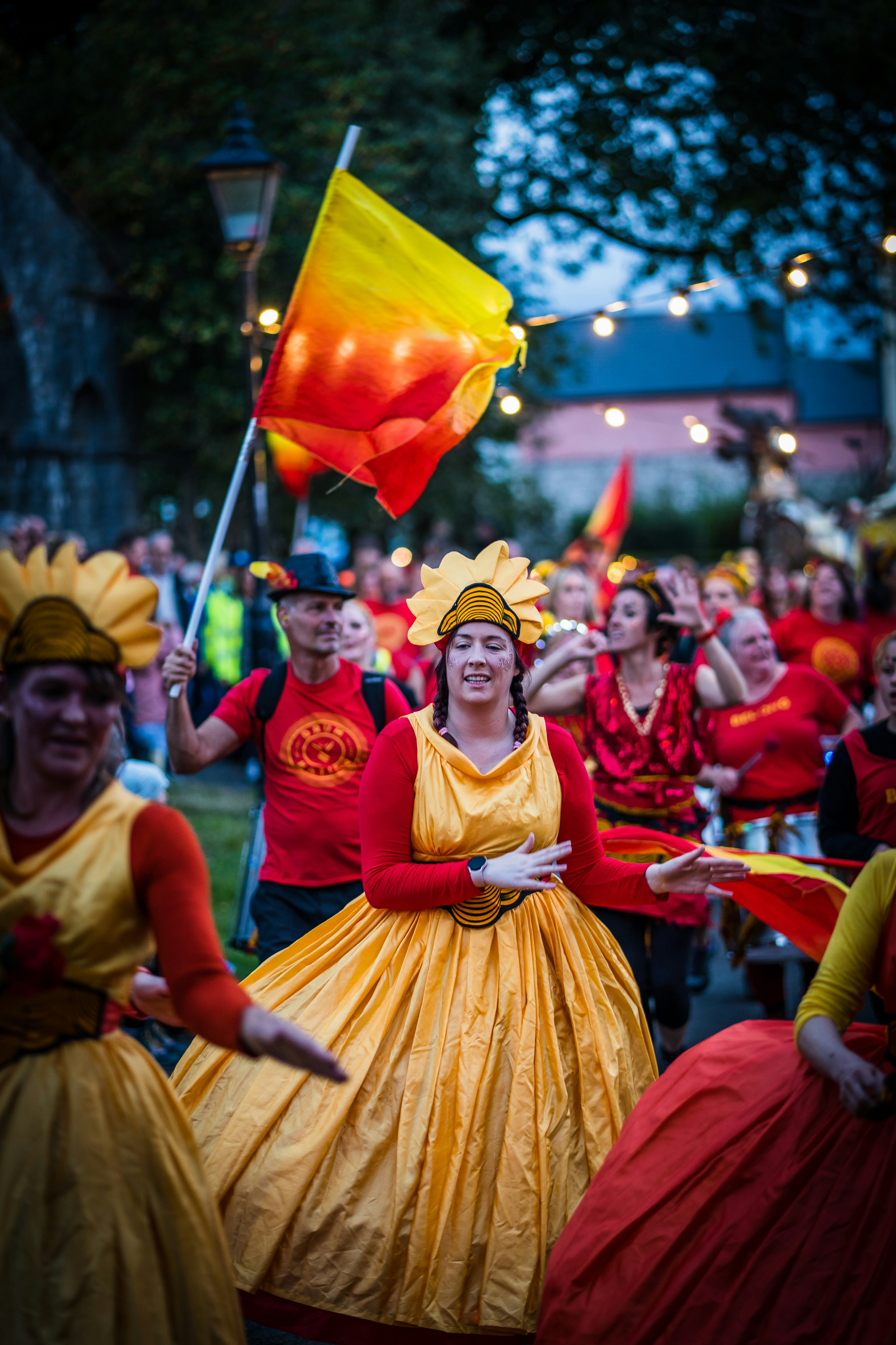 Sunflower Parade: A Burst of Yellow Under Strings of Light