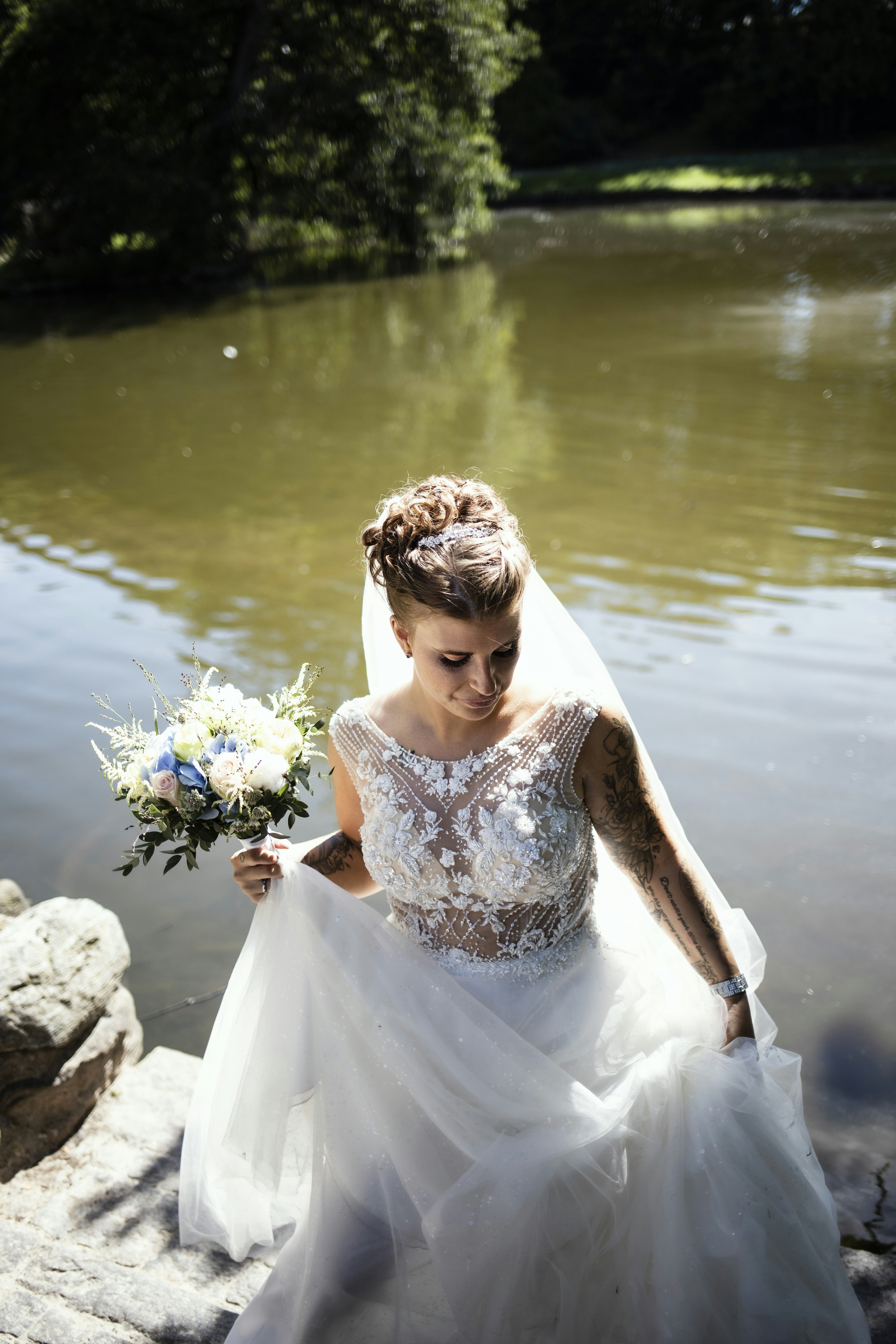 Riverside Bride: lace, veil, and bouquet framed by afternoon light