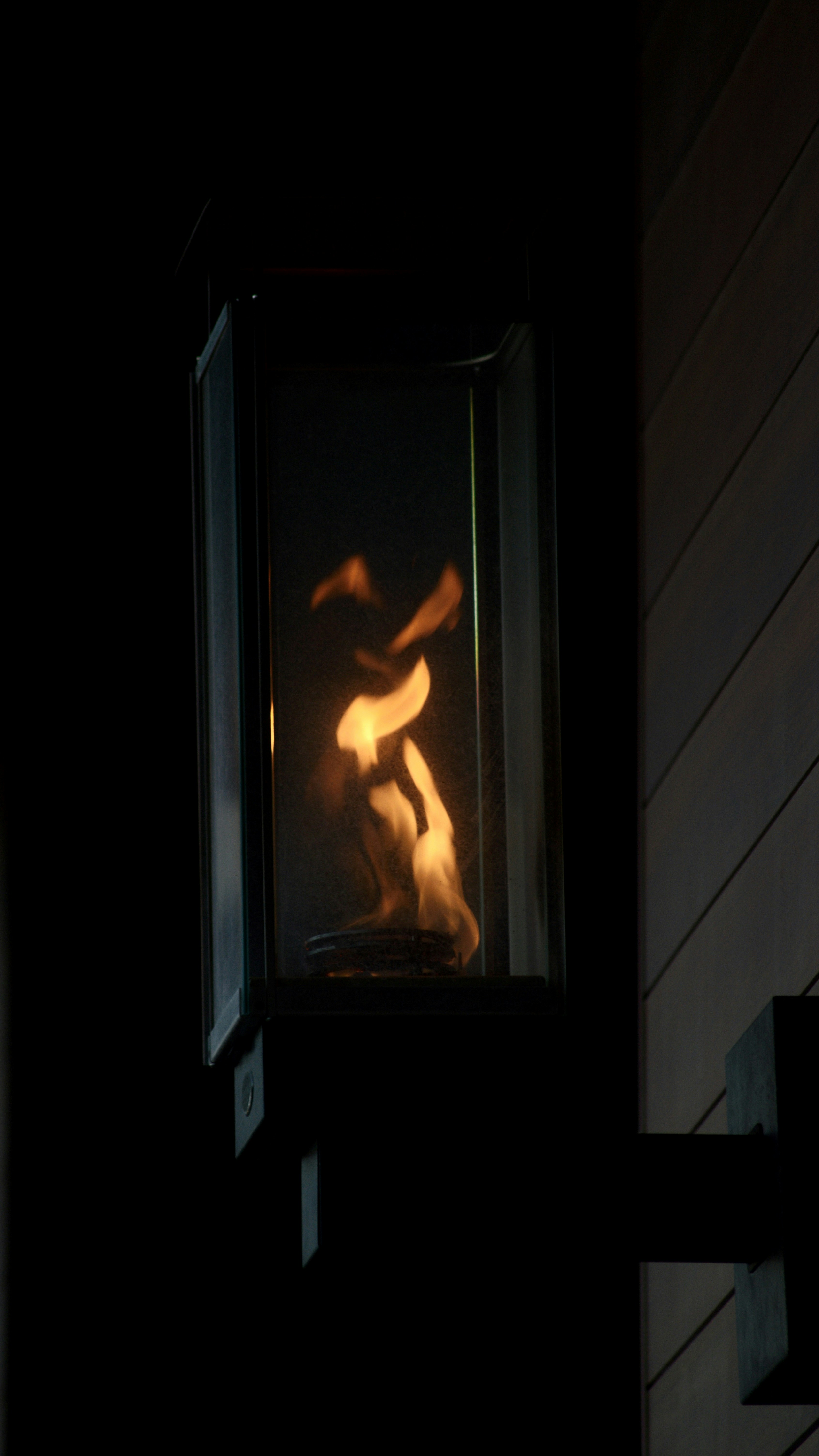 Nightbound Lantern: A Quiet Flame in a Shadowed Facade