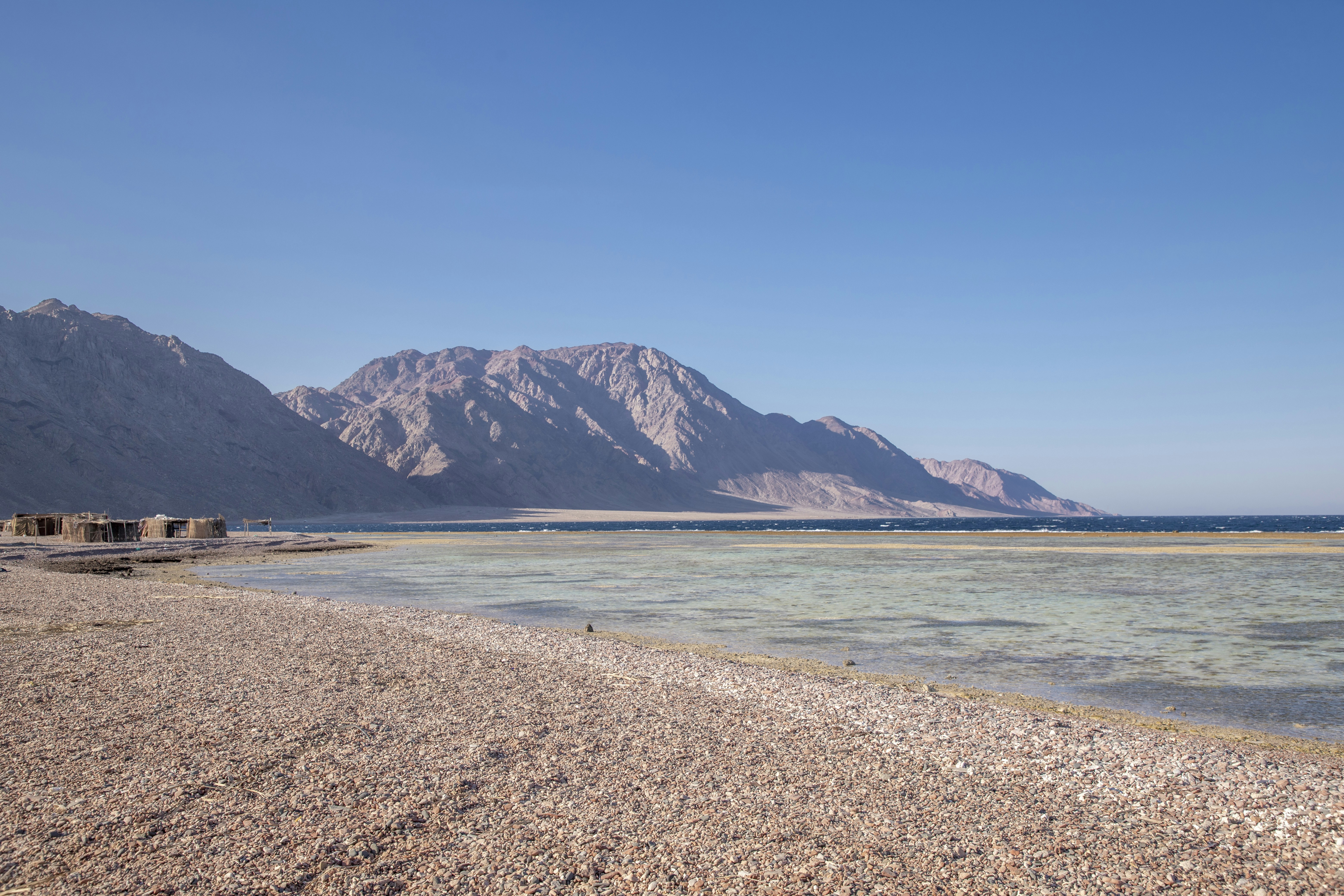 Pebble Beach at the Foot of a Rugged Horizon