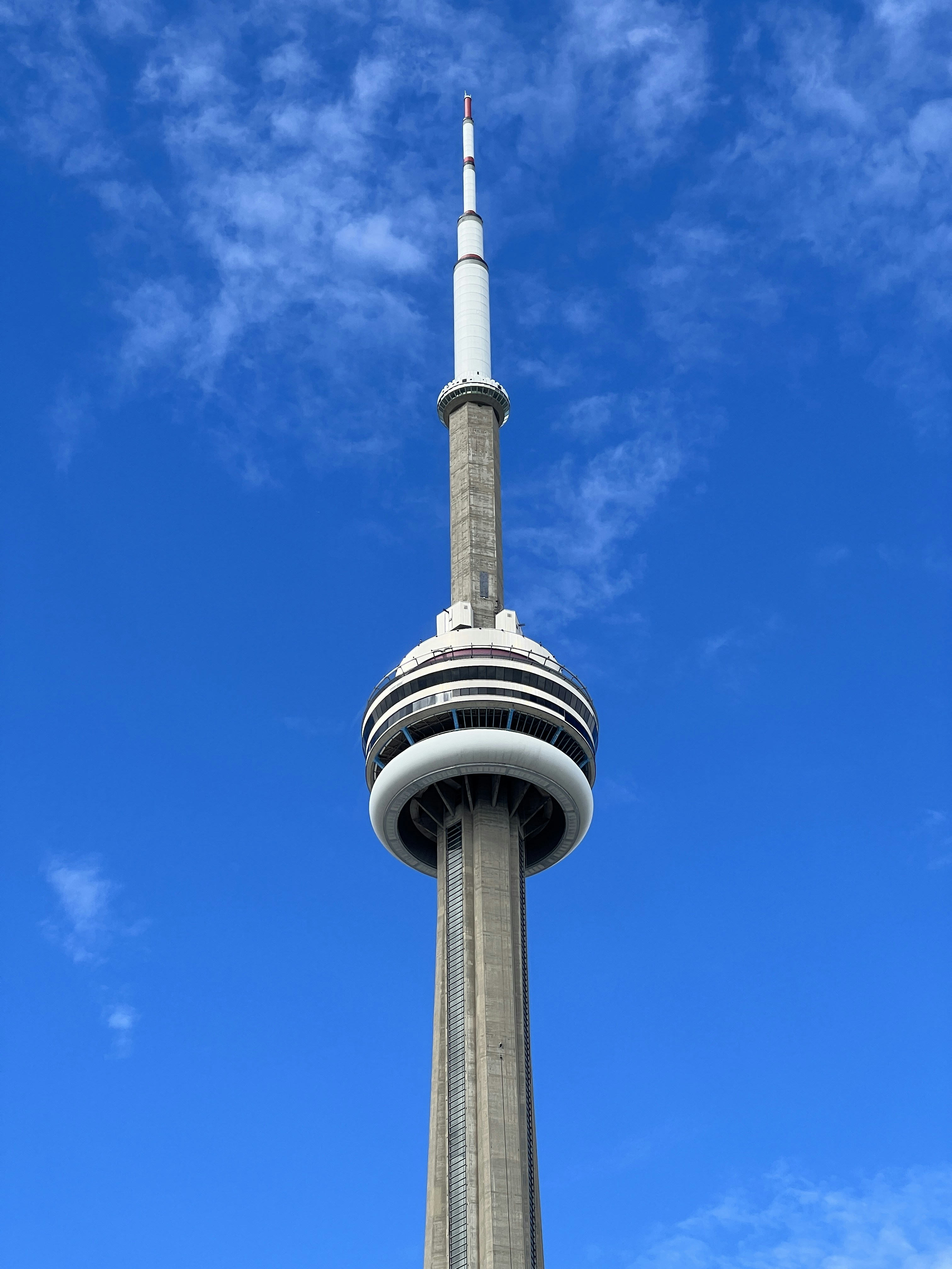 A tall tower with a pointed top with CN Tower in the background photo ...