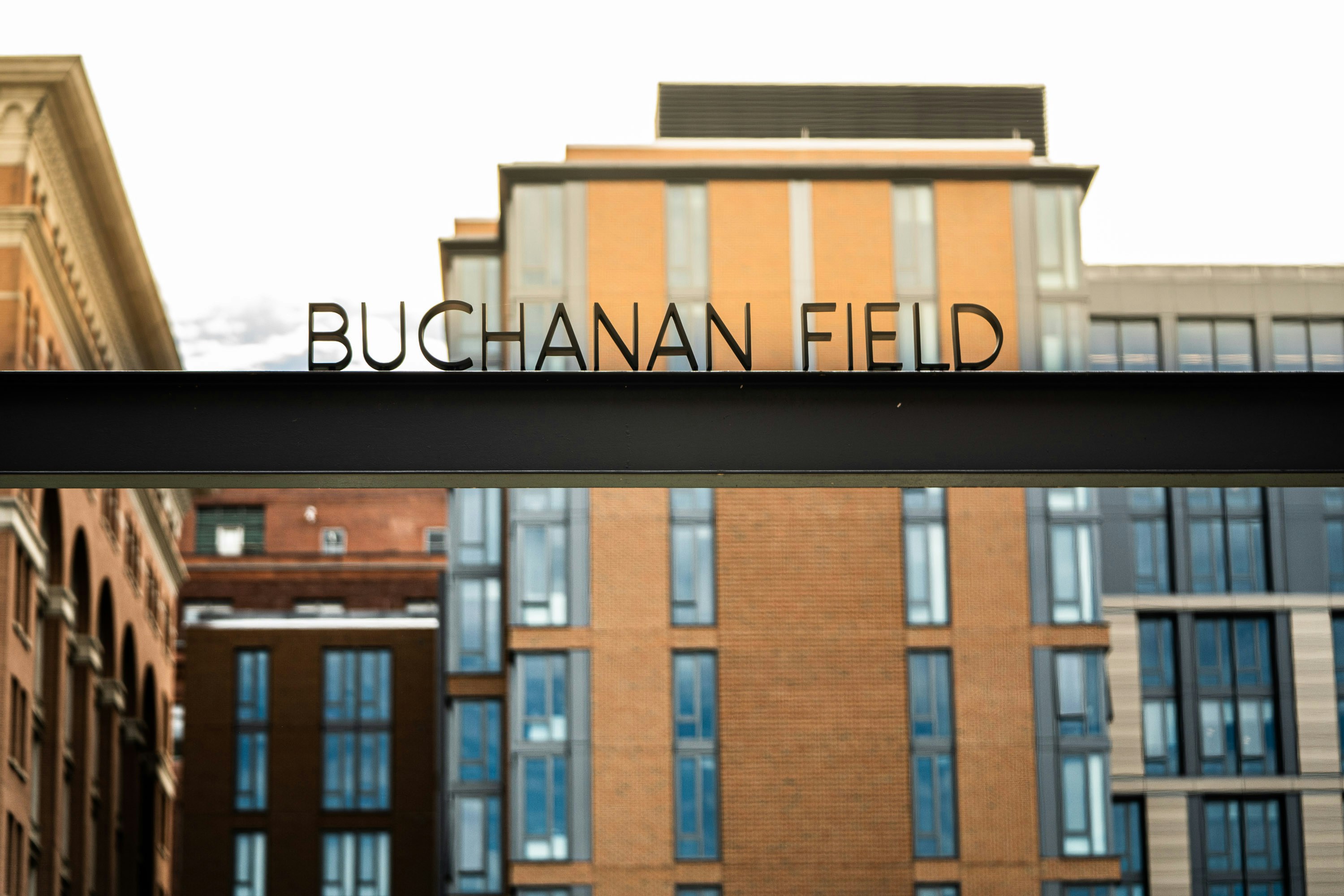 A large building with a sign on it photo – Free Buchanan field Image on ...