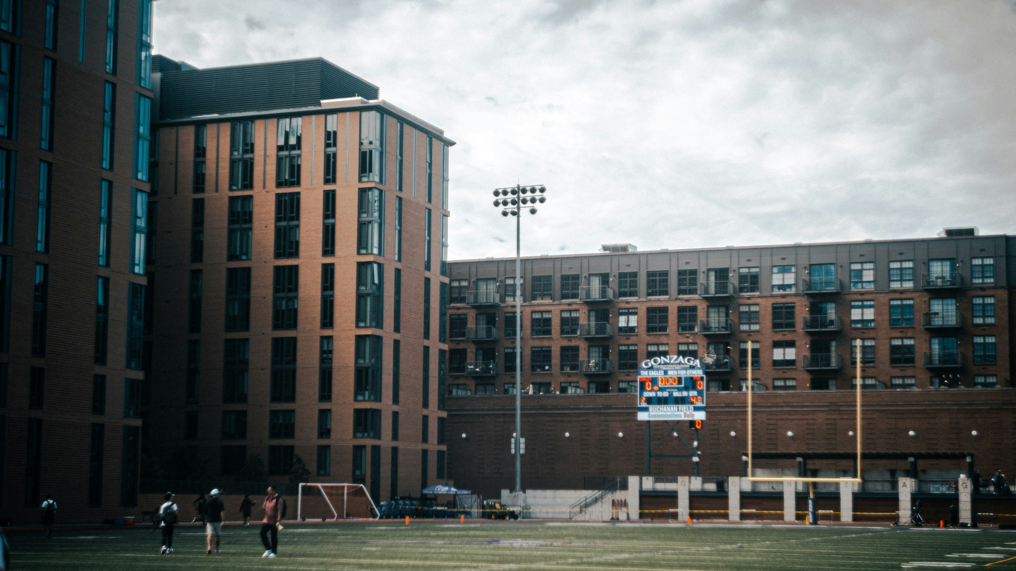A group of people walking in front of a building photo – Free Buchanan ...