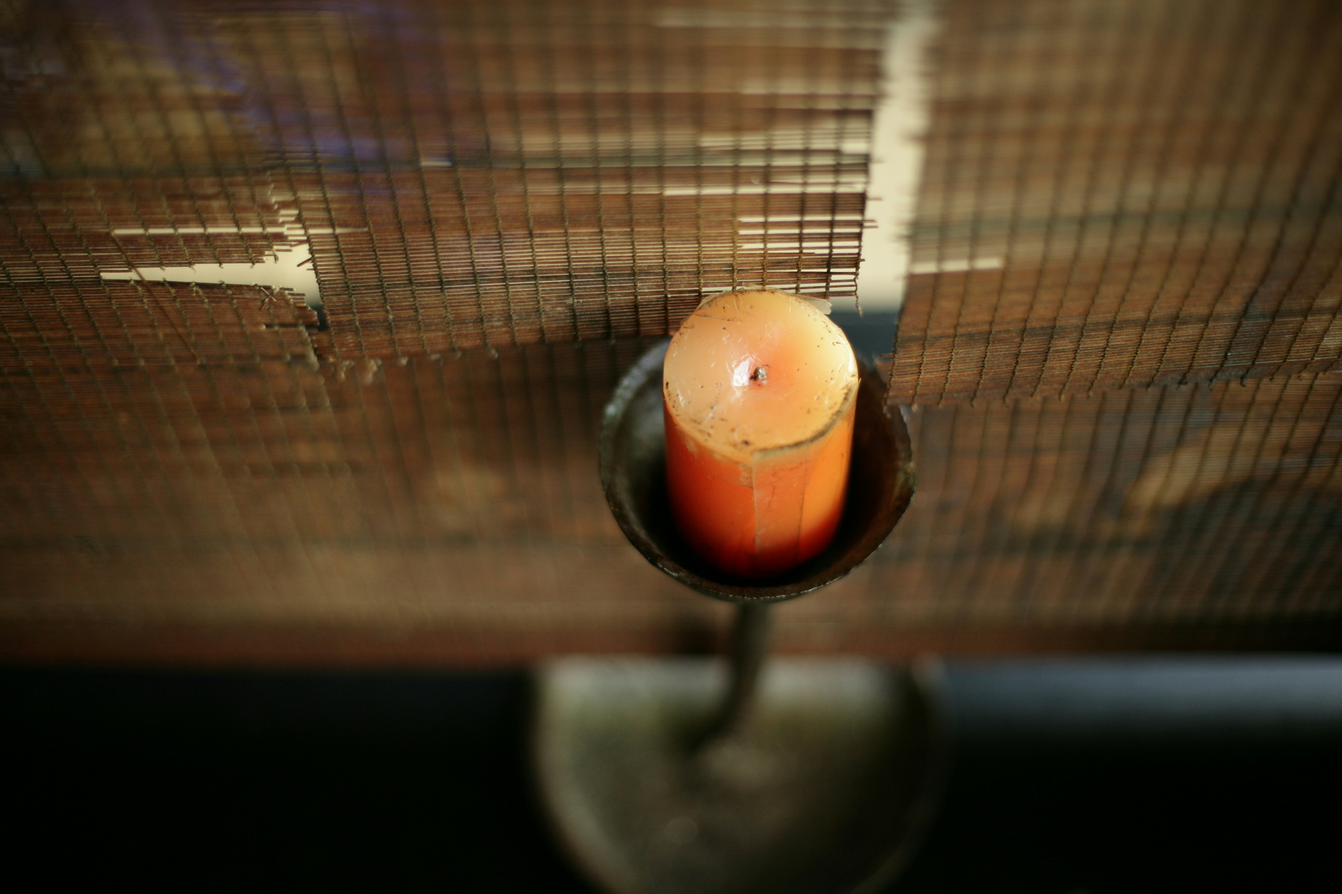 Ember on a Grid: Close-Up of a Candle Core in Industrial Light