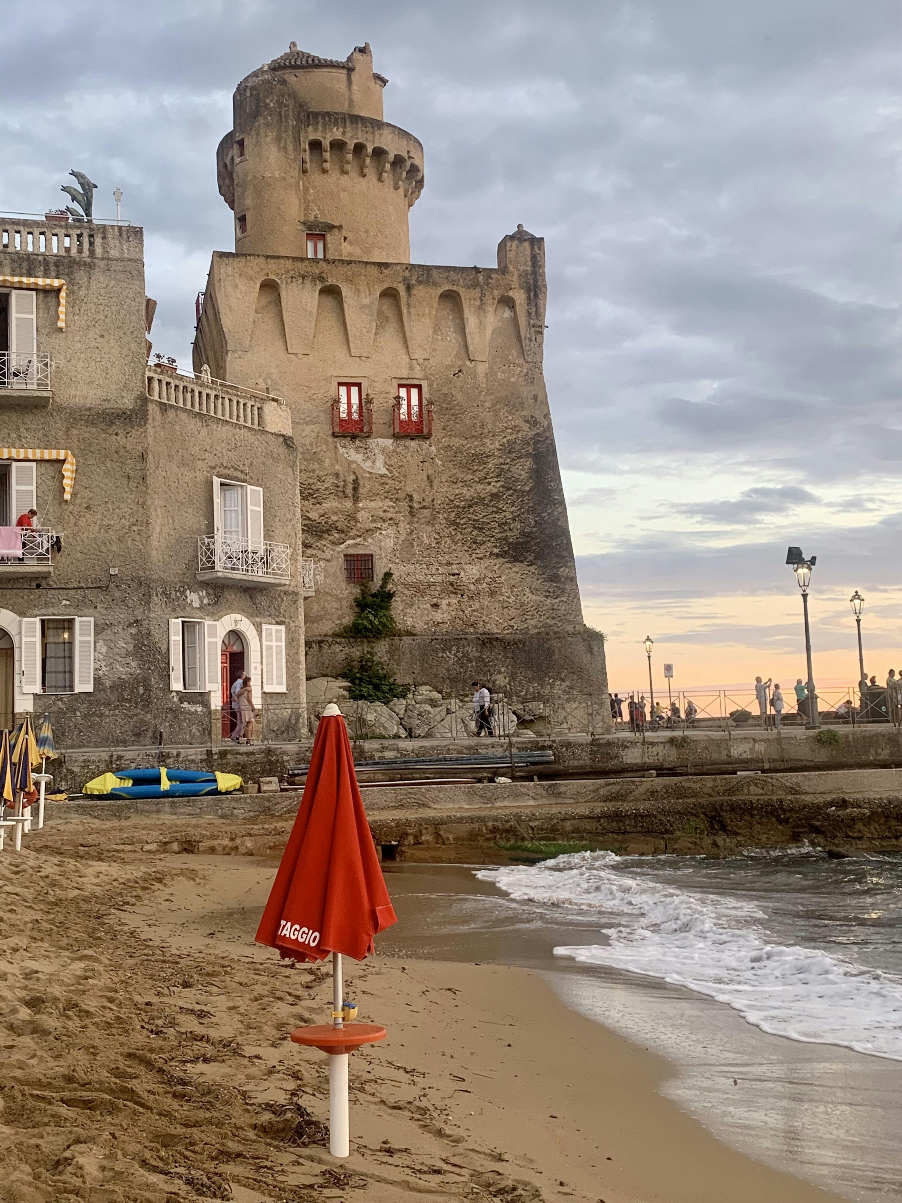 Red Umbrella by the Bastion: Echoes on a Bygone Shore