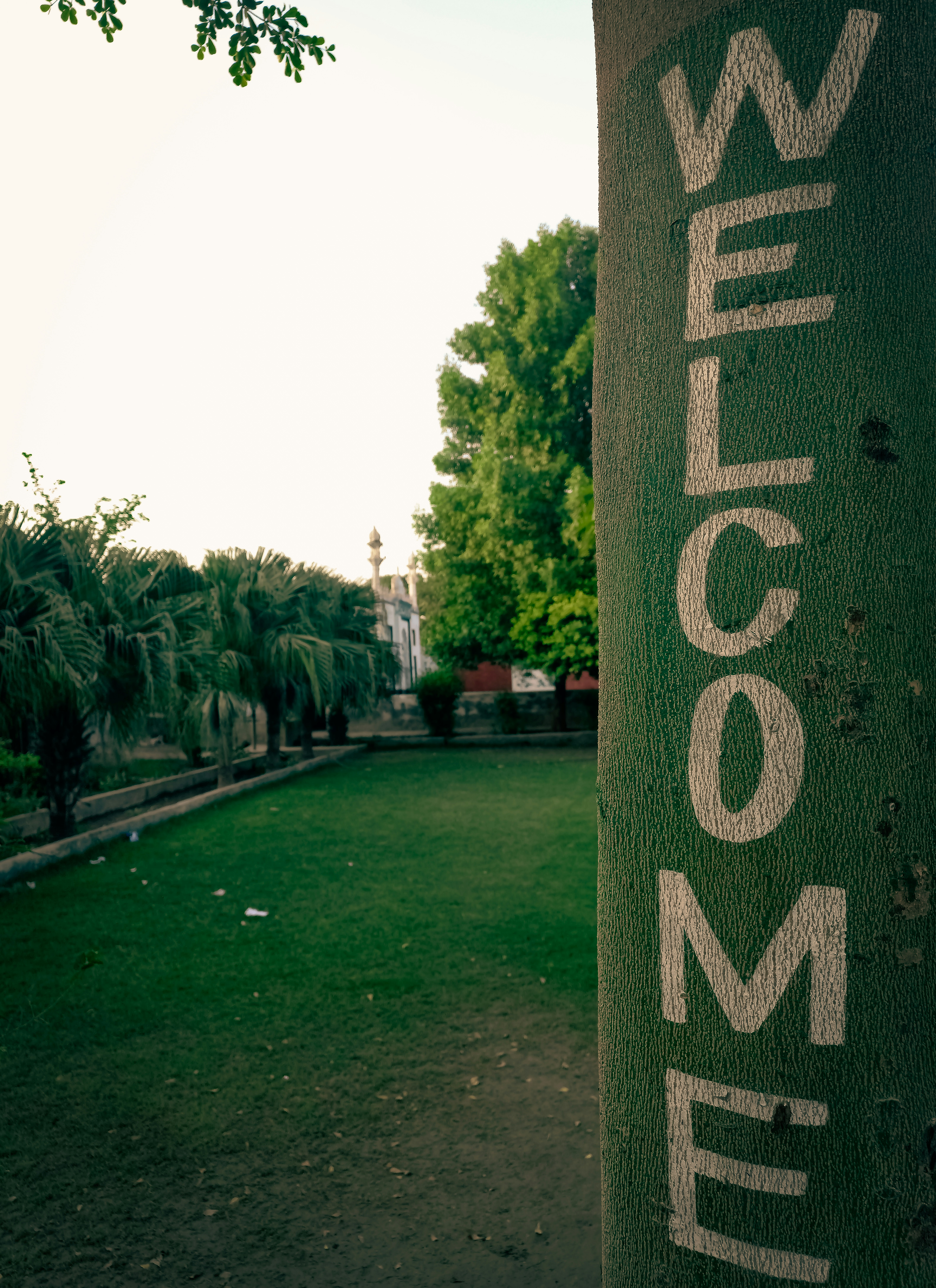 Vertical Welcome: A Sunlit Park Framed by a Bold Pillar
