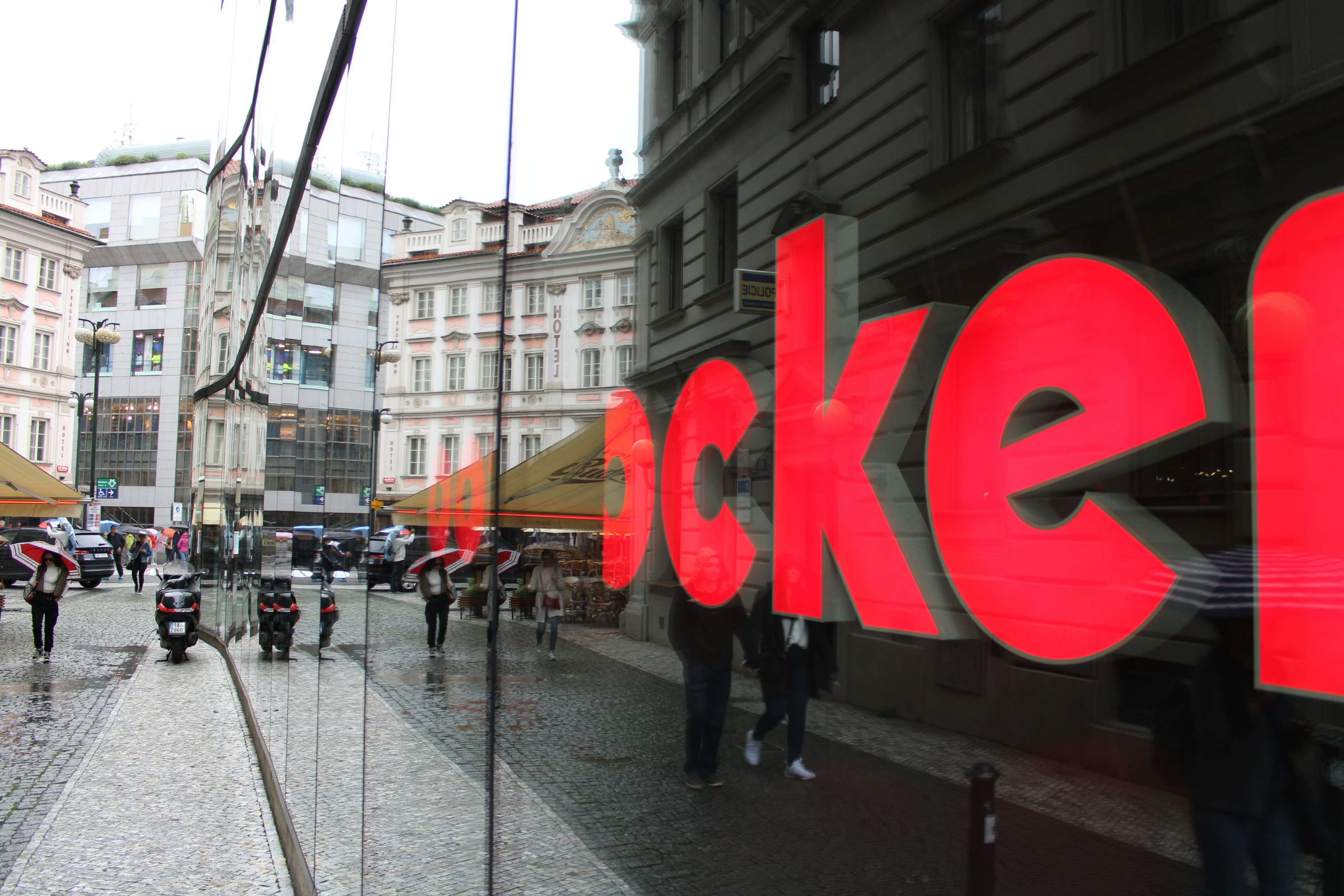 A large red sign on a building photo – Free Reflection Image on Unsplash