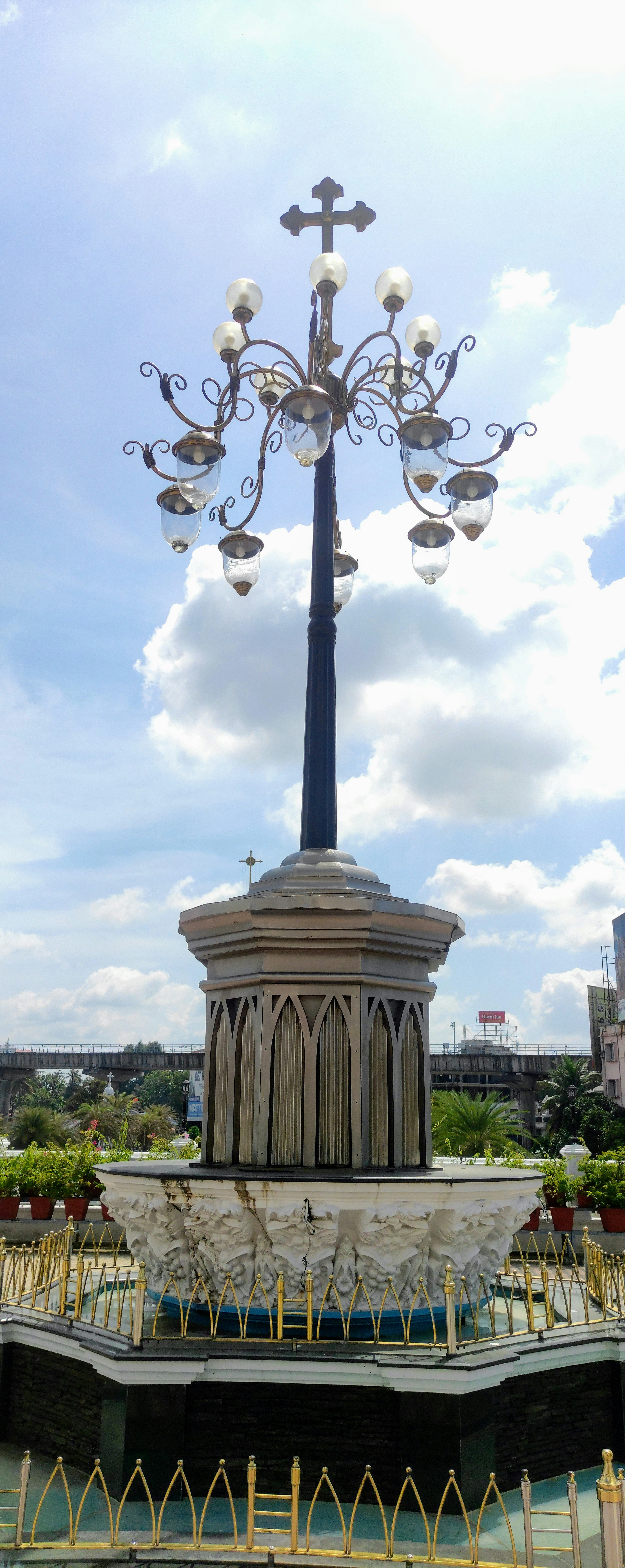A large metal tower with a cross on top photo – Free Lamp post Image on ...