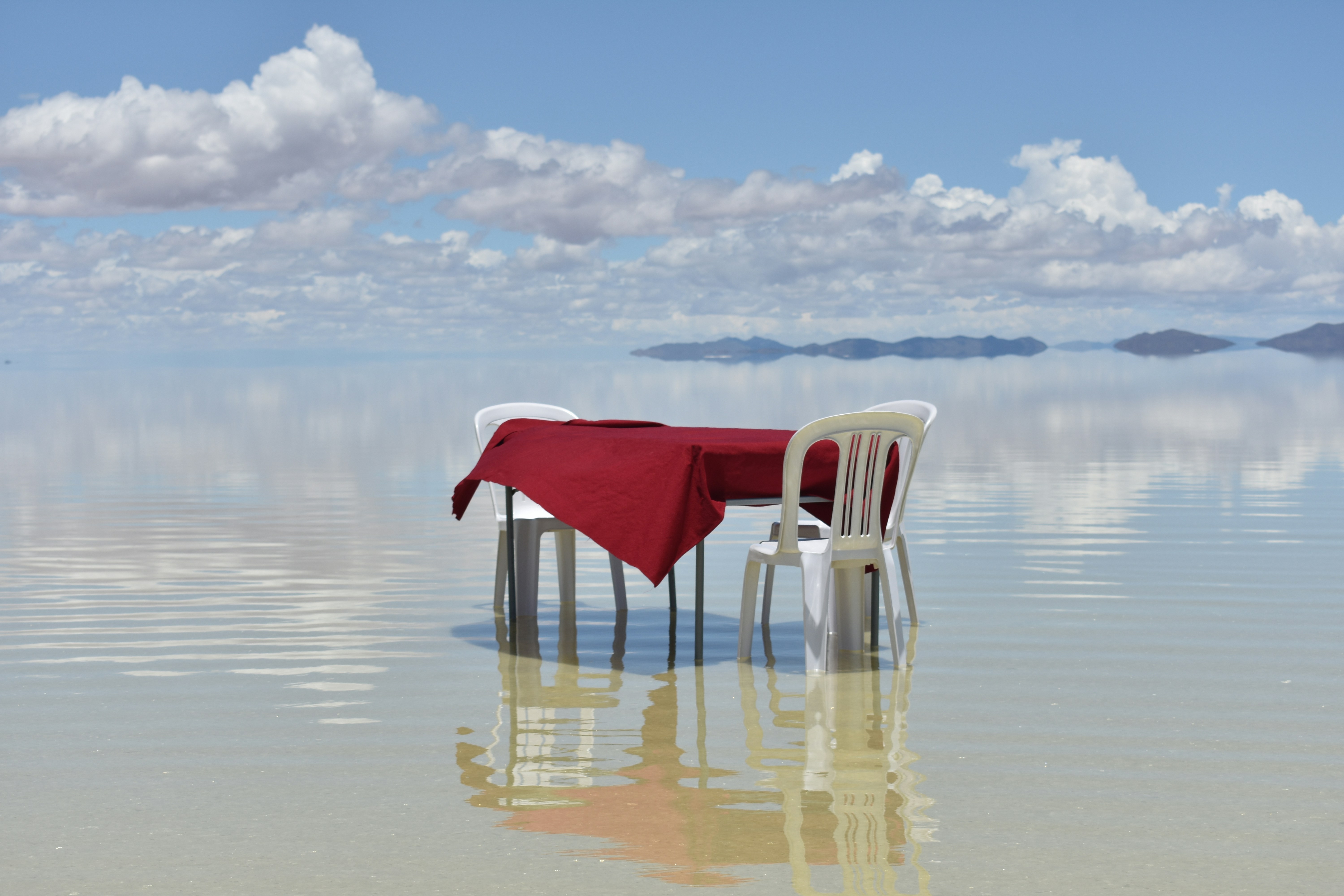 a chair and a table on a beach