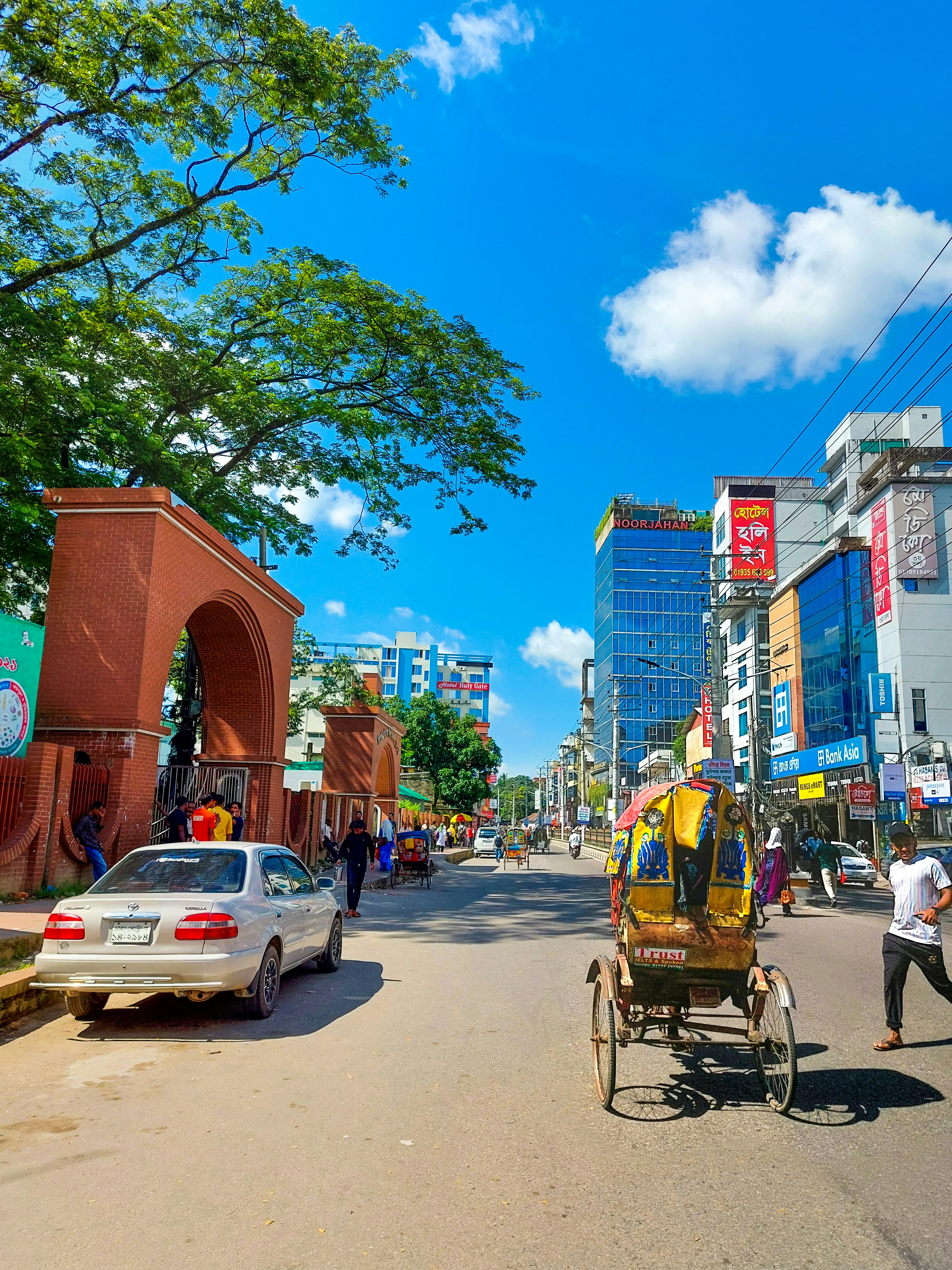 The Cart at the Crossroads: Sunlit Street Life Under a Blue Sky