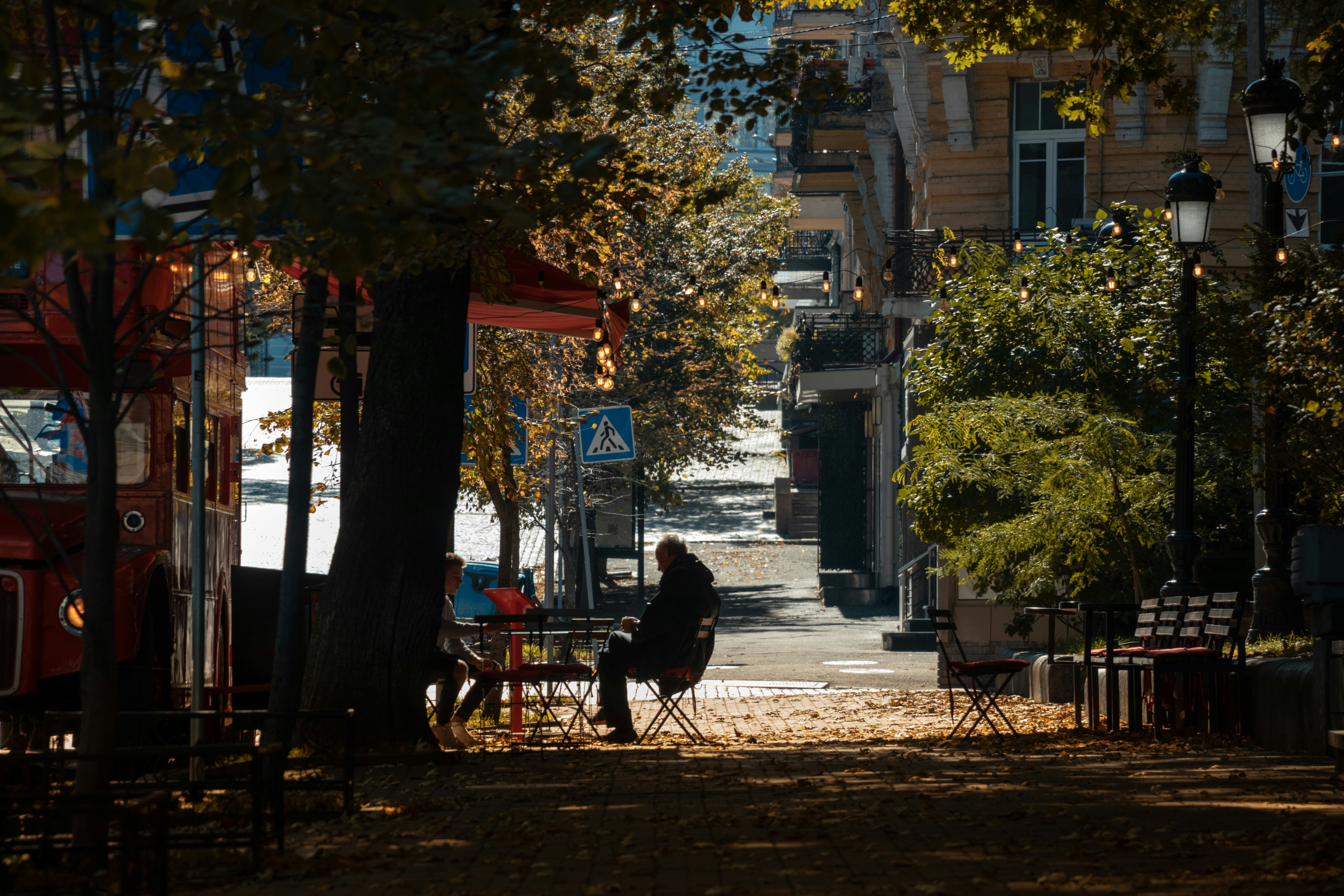 Morning autumn vibes in the city. Two friends in the cafe.