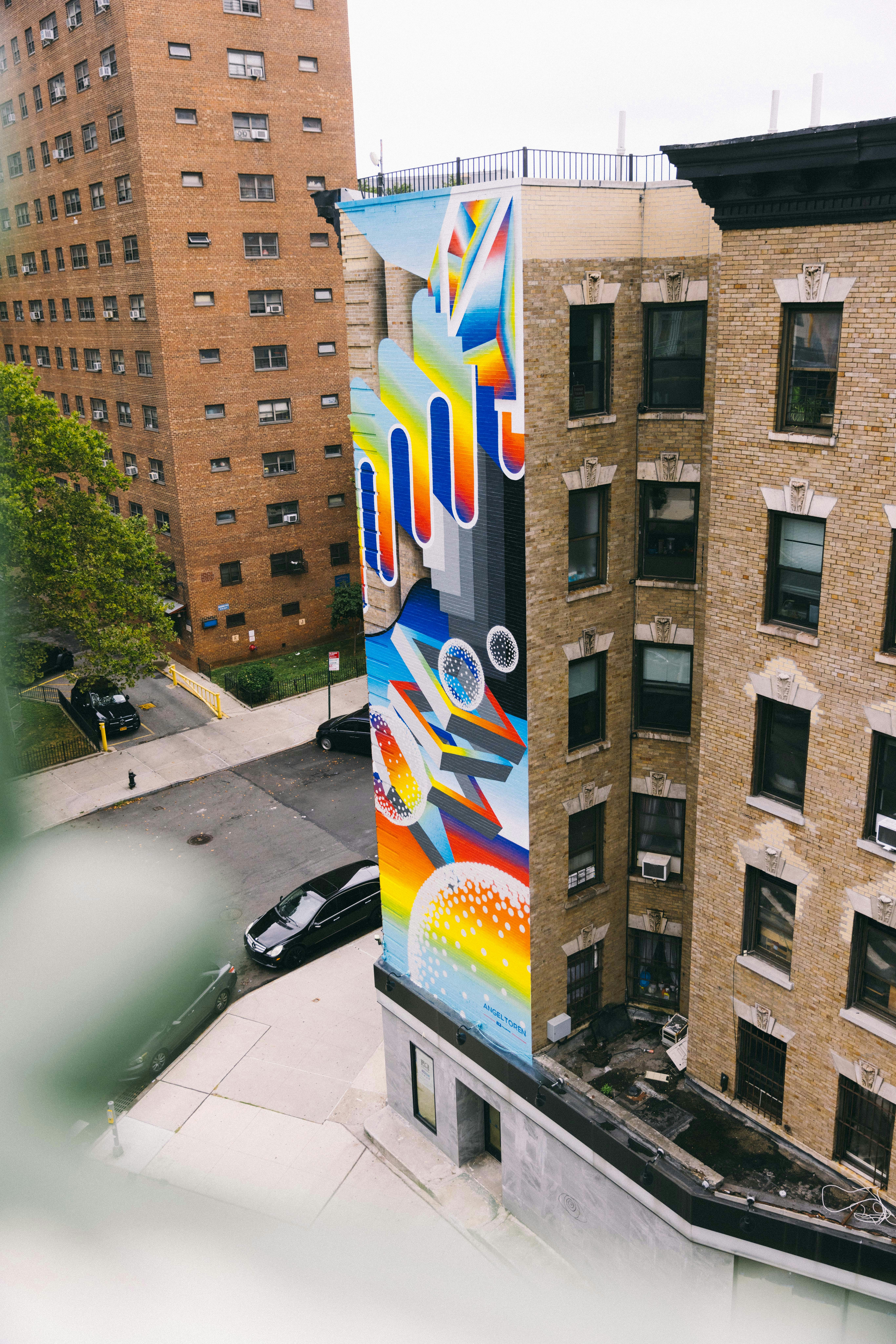 Vertical Prism: Bold mural climbs a brick tower over a city street