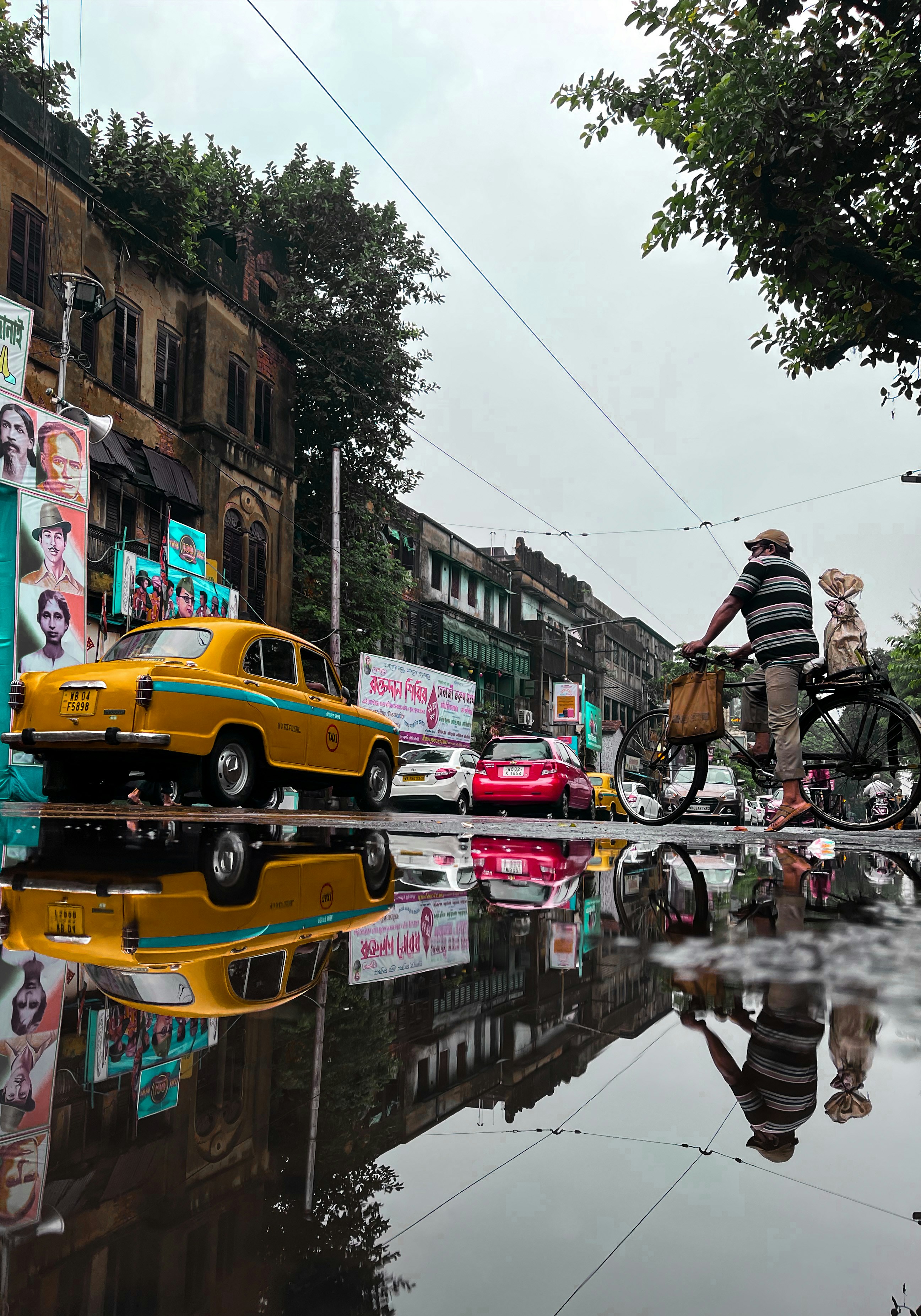 Yellow taxi reflections and moving silhouettes on a rain-kissed street