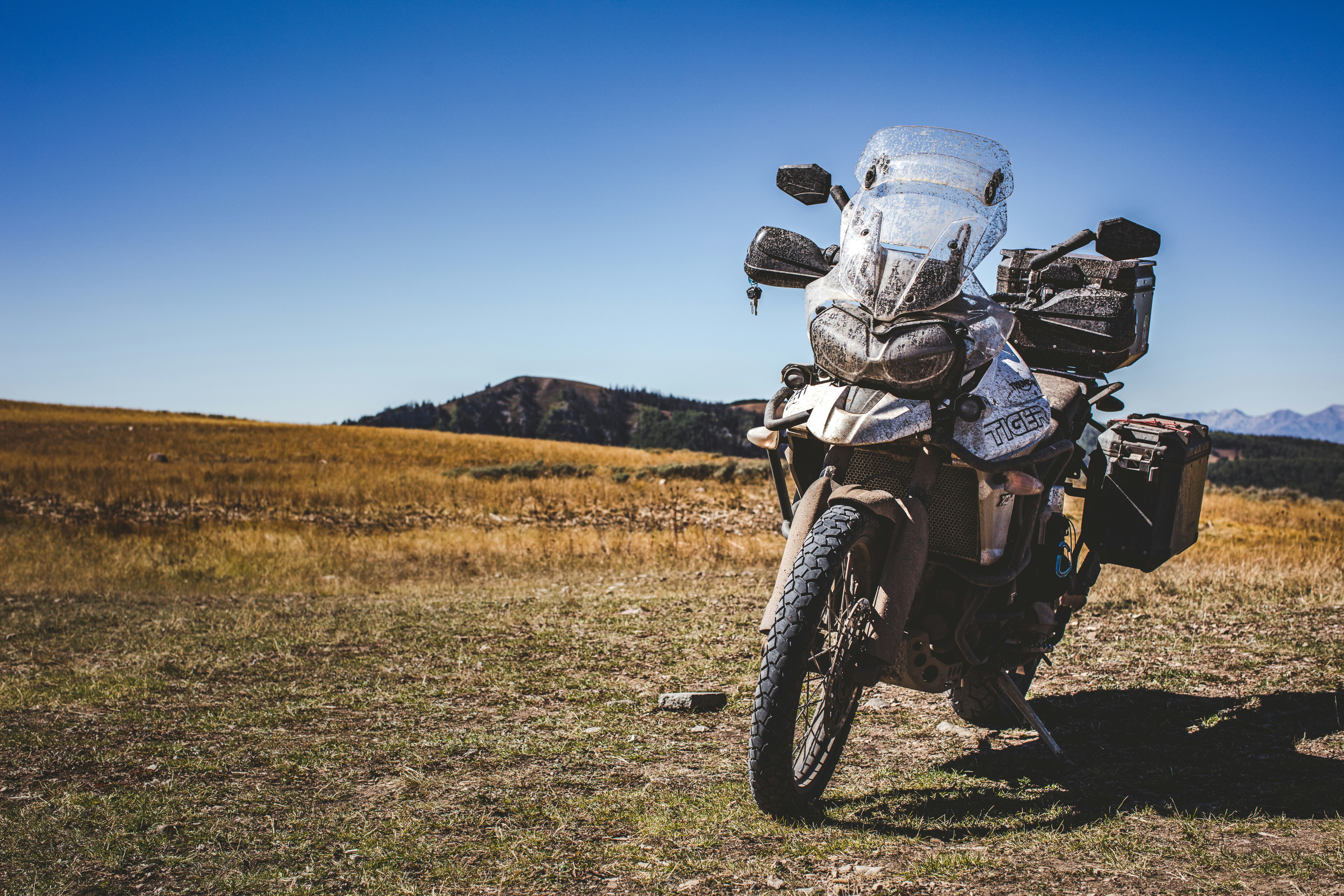A motorcycle parked in a field photo – Free Motorcycle Image on Unsplash