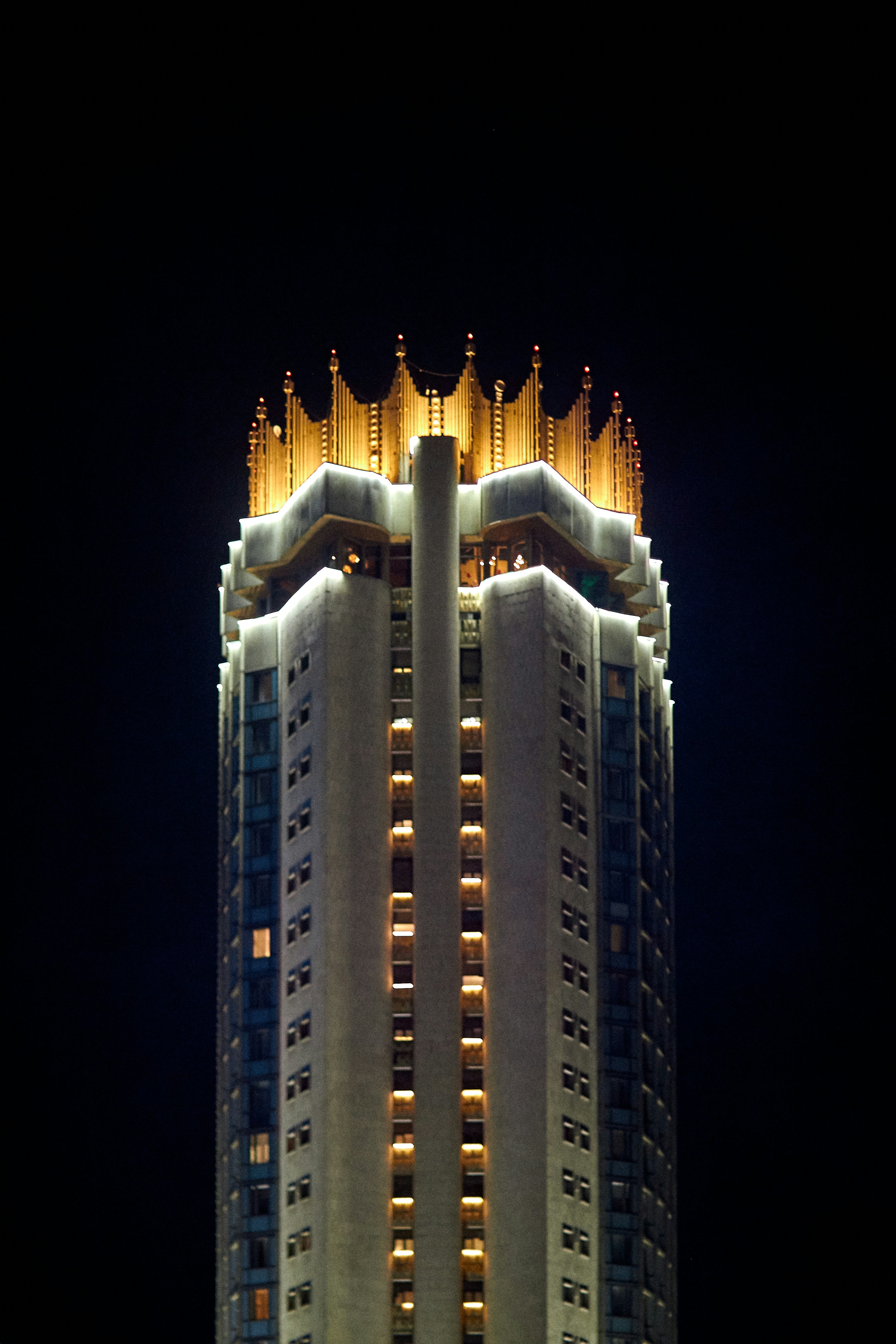 A tall building with lights at night photo – Free Building Image on ...
