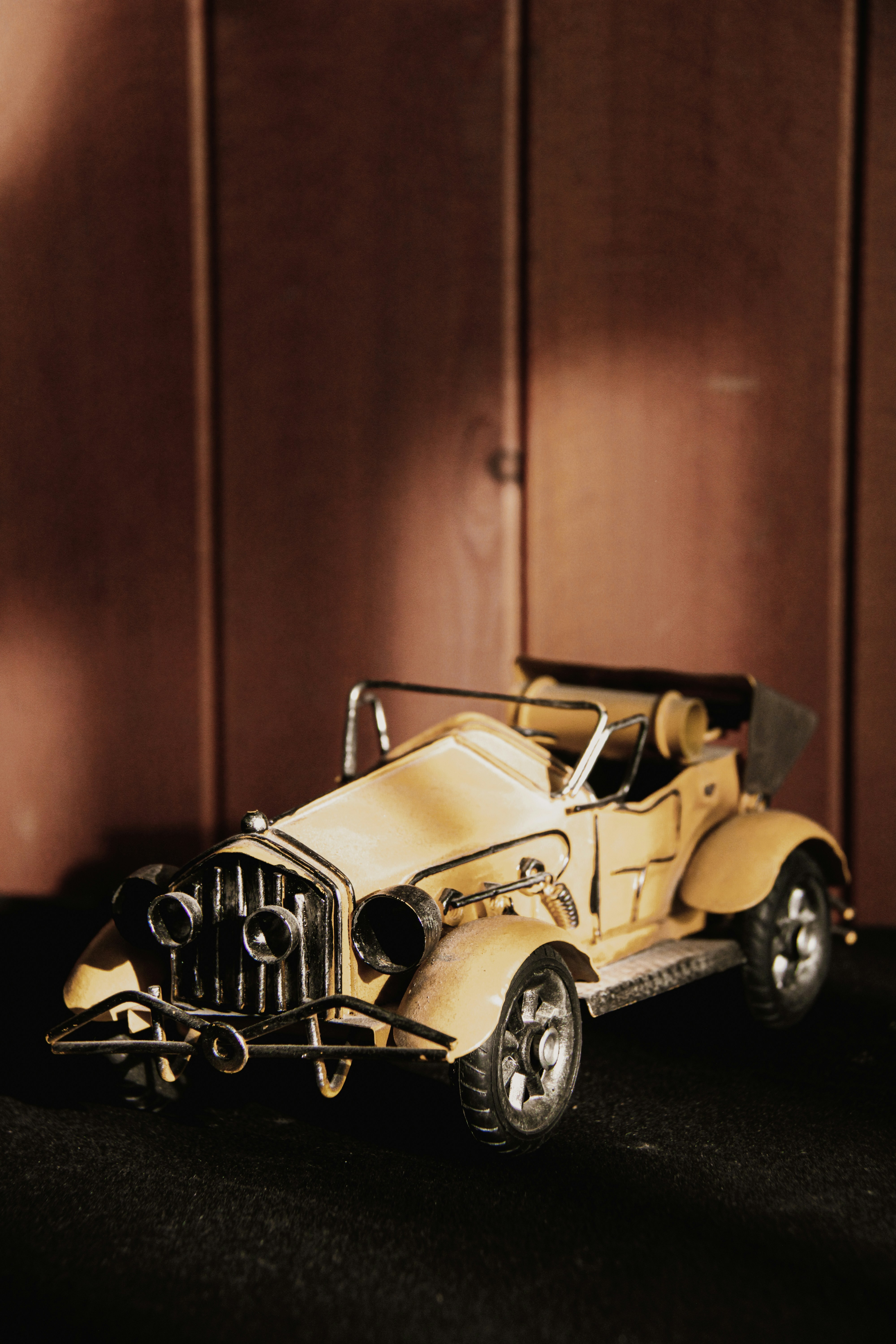 Amber-glow Vintage Toy Convertible on a Wooden Stage