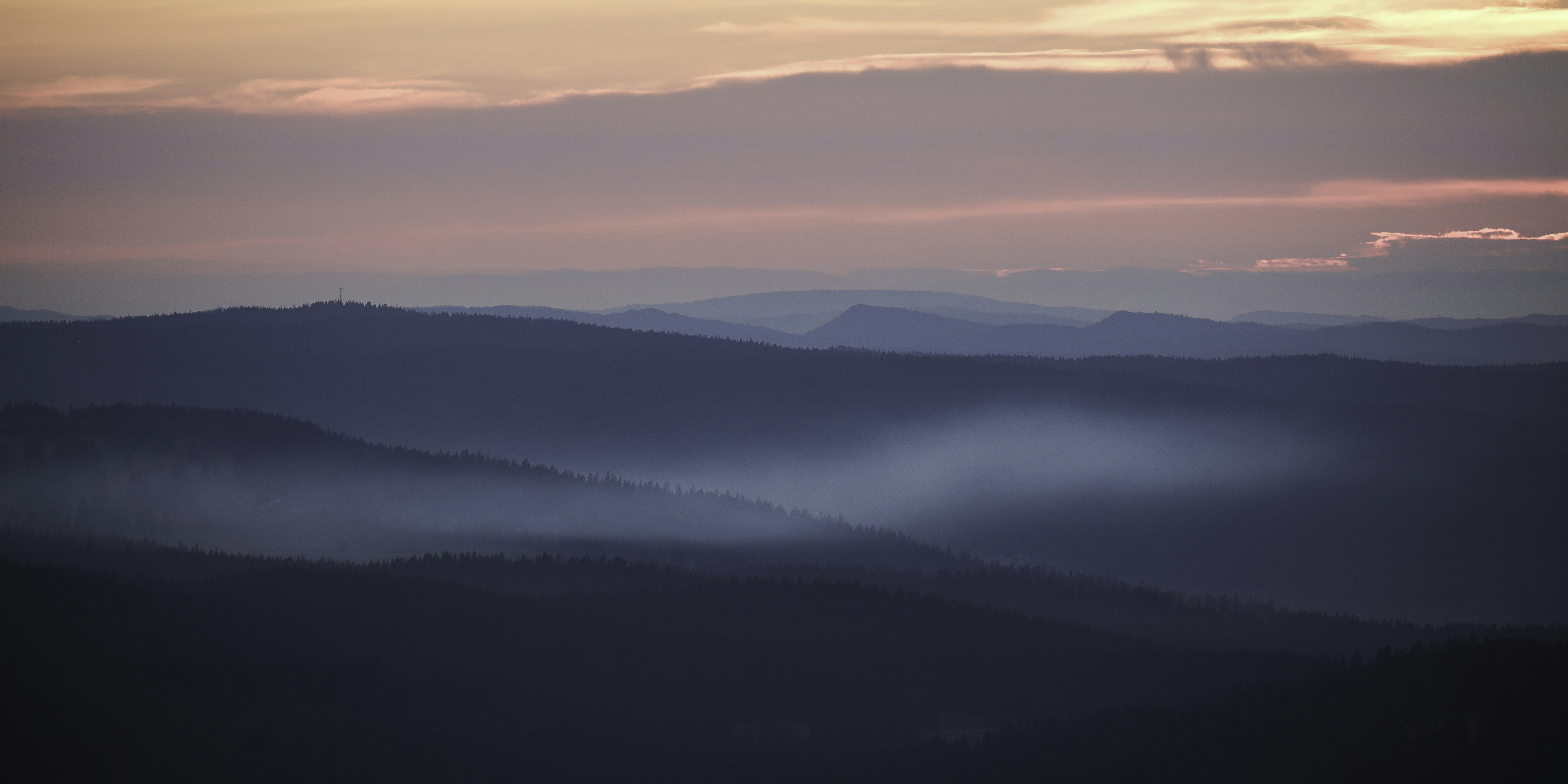 A foggy valley with mountains in the distance photo – Free Fog Image on ...