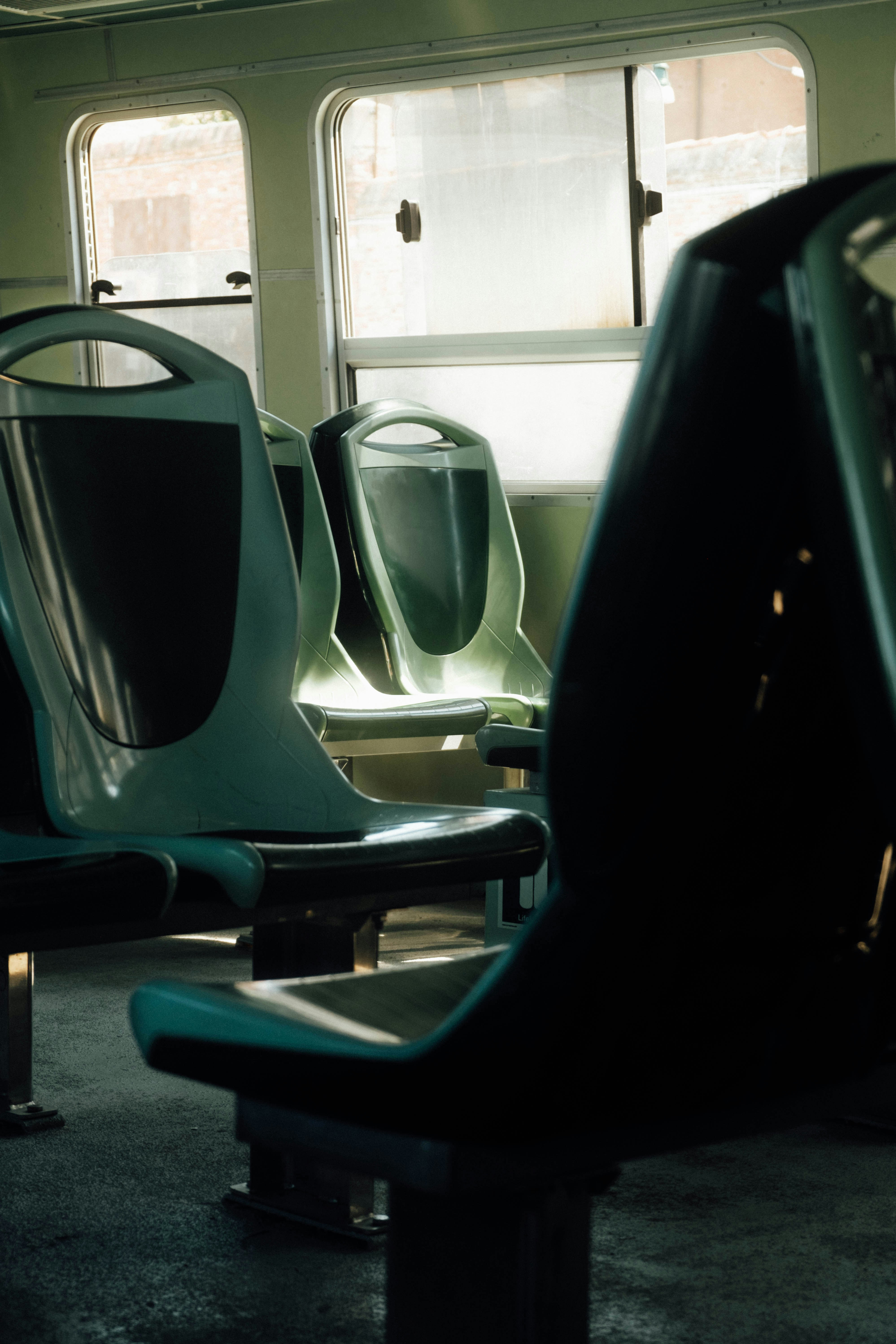 Sunlit Aisle Seat in a Quiet Green Bus Interior