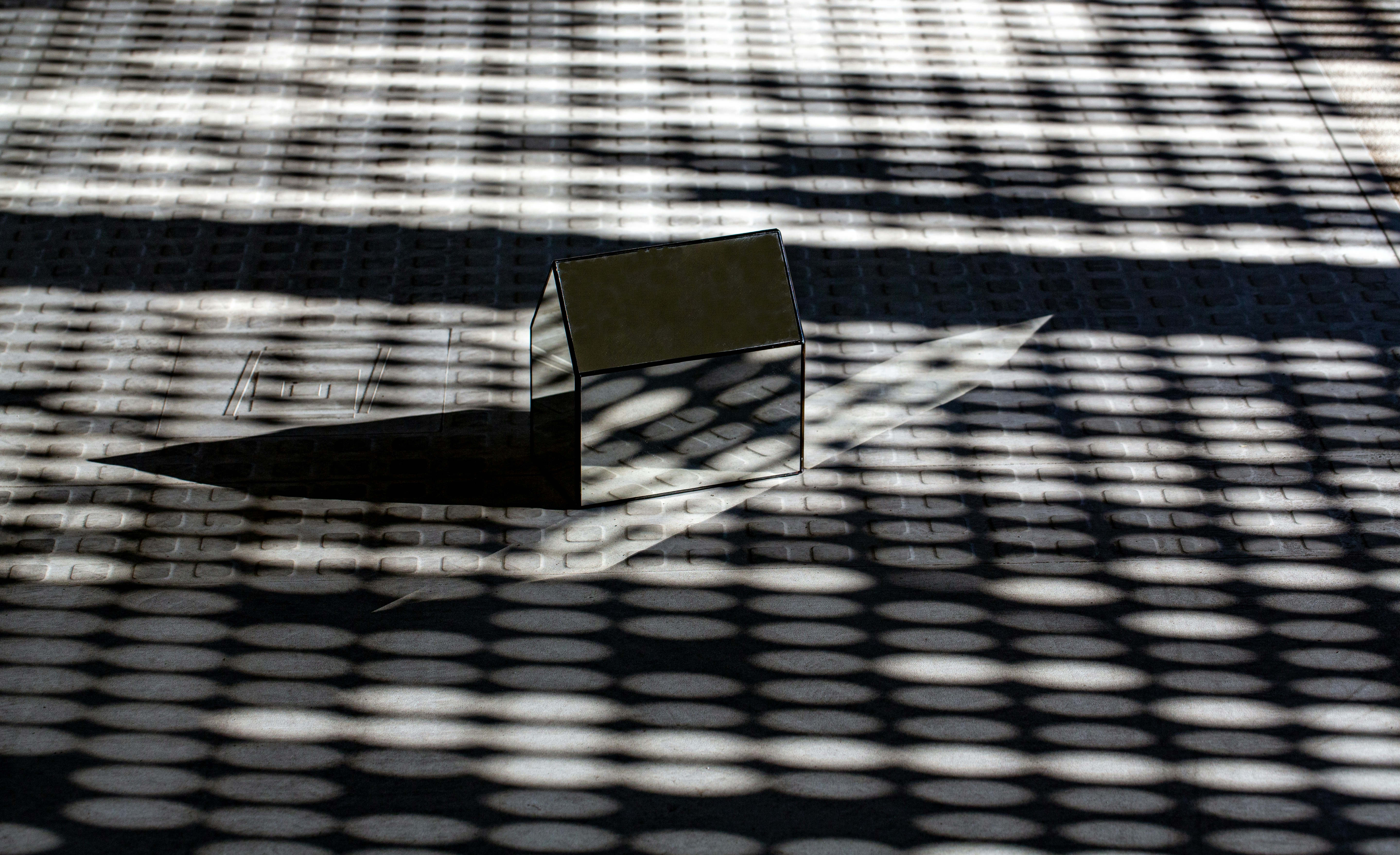 Glass Cube on a Dappled Floor: Shadows Weaving a Circular Lattice