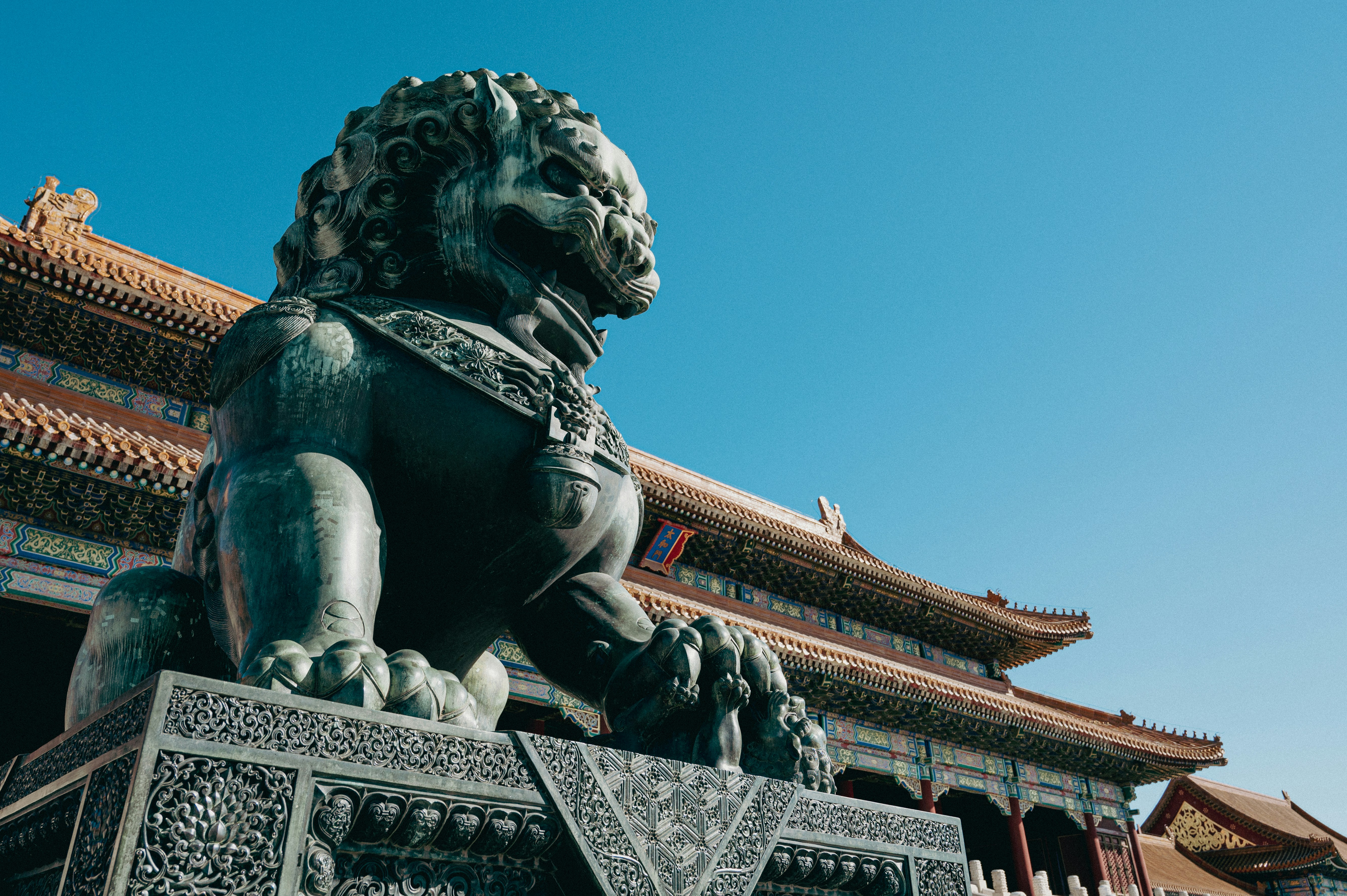Azure Guardian at the Imperial Roof: A Carved Lion Stands Watch