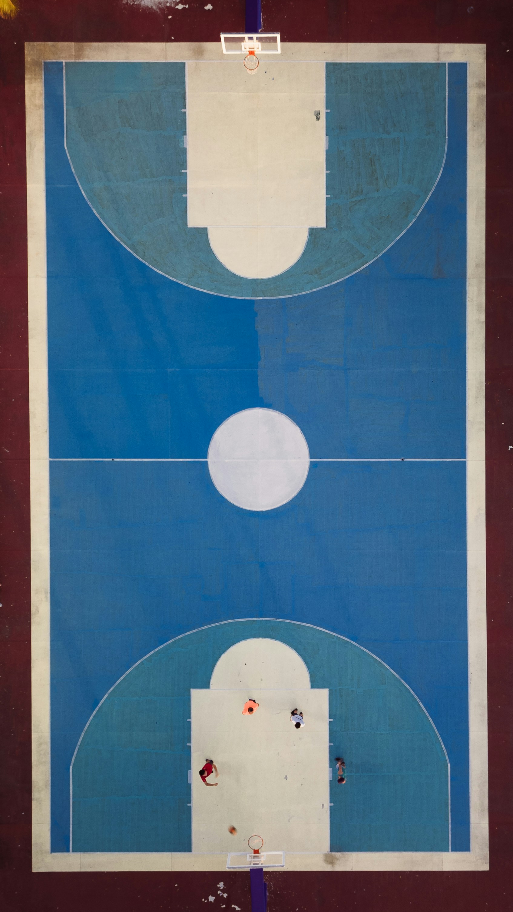 Blue Court Symmetry: Aerial Portrait of a Centered Basketball Court