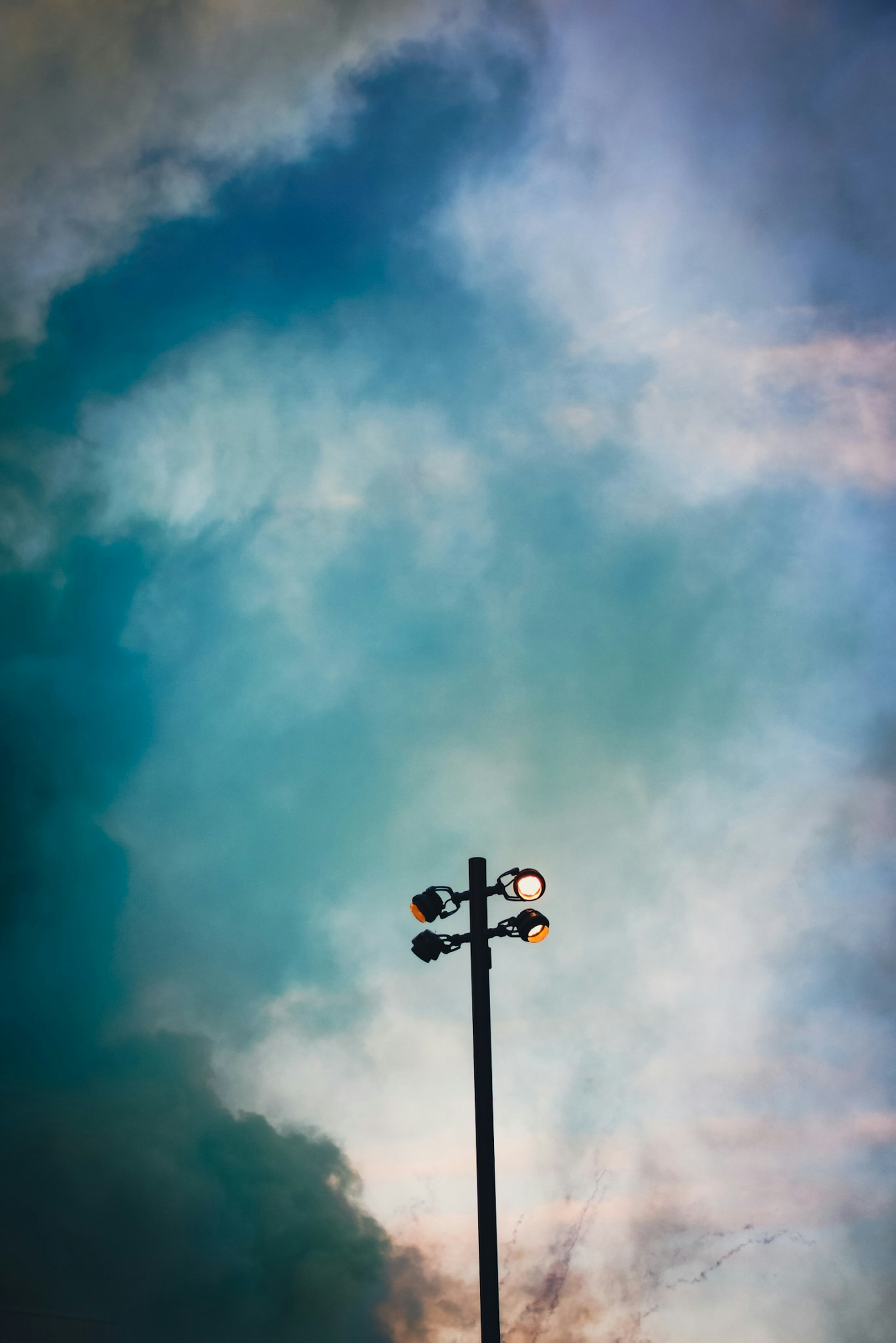 A traffic light towers over a street photo – Free Lamp post Image on ...