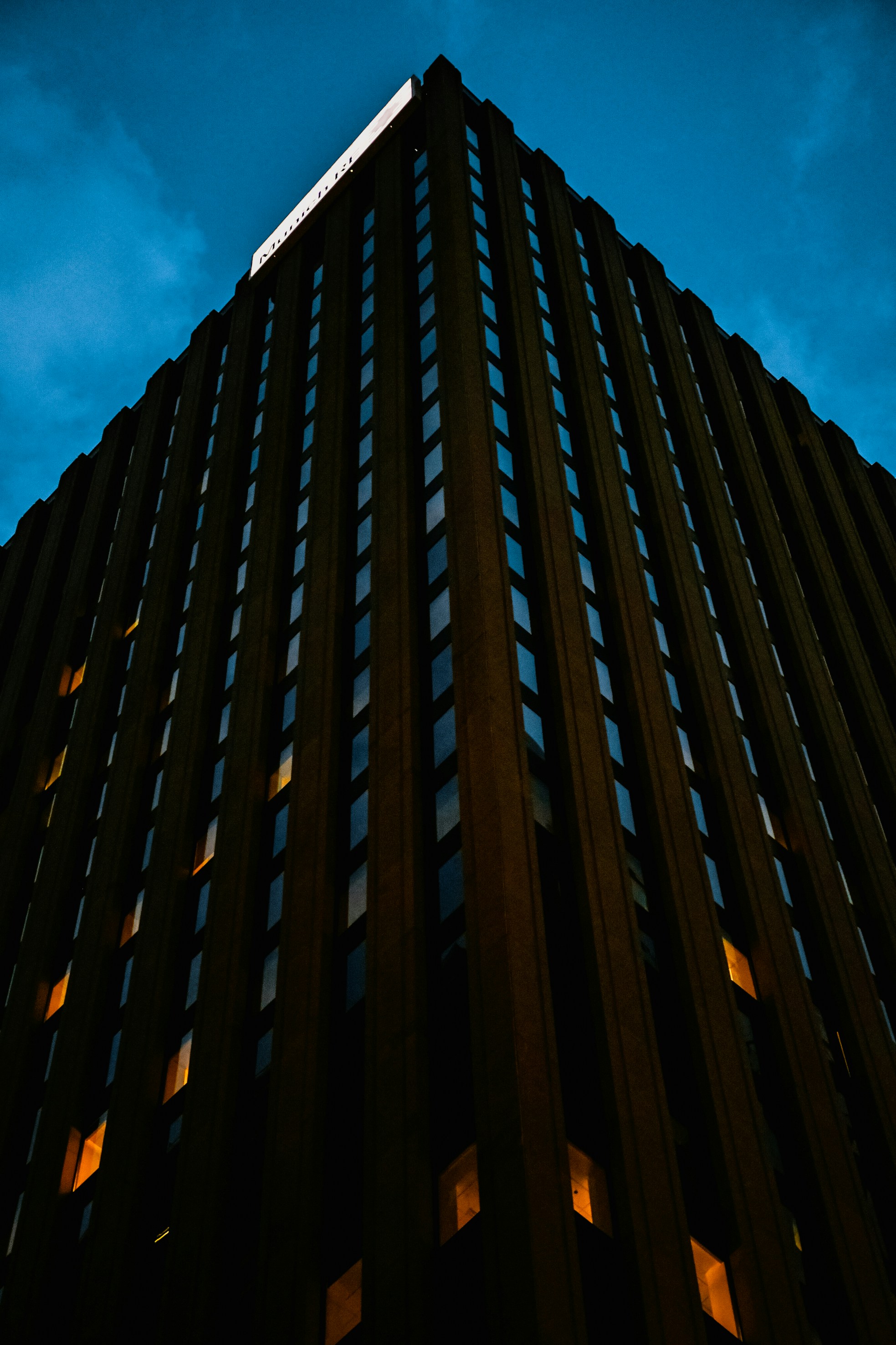 A tall building with many windows with CBS Building in the background ...