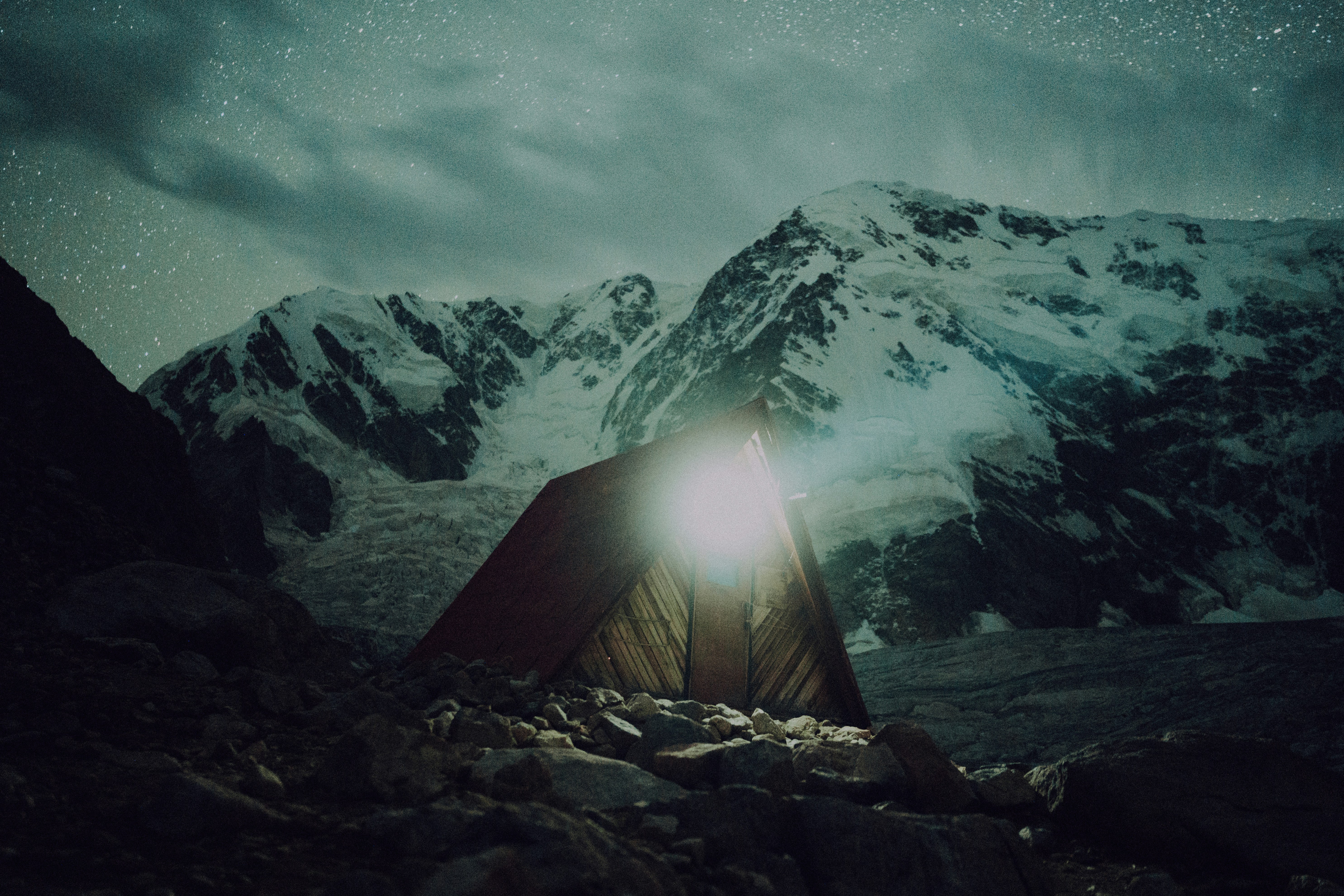 Glacial Lantern: A Snowbound Tent Beneath a Star-Swept Alpine Ridge