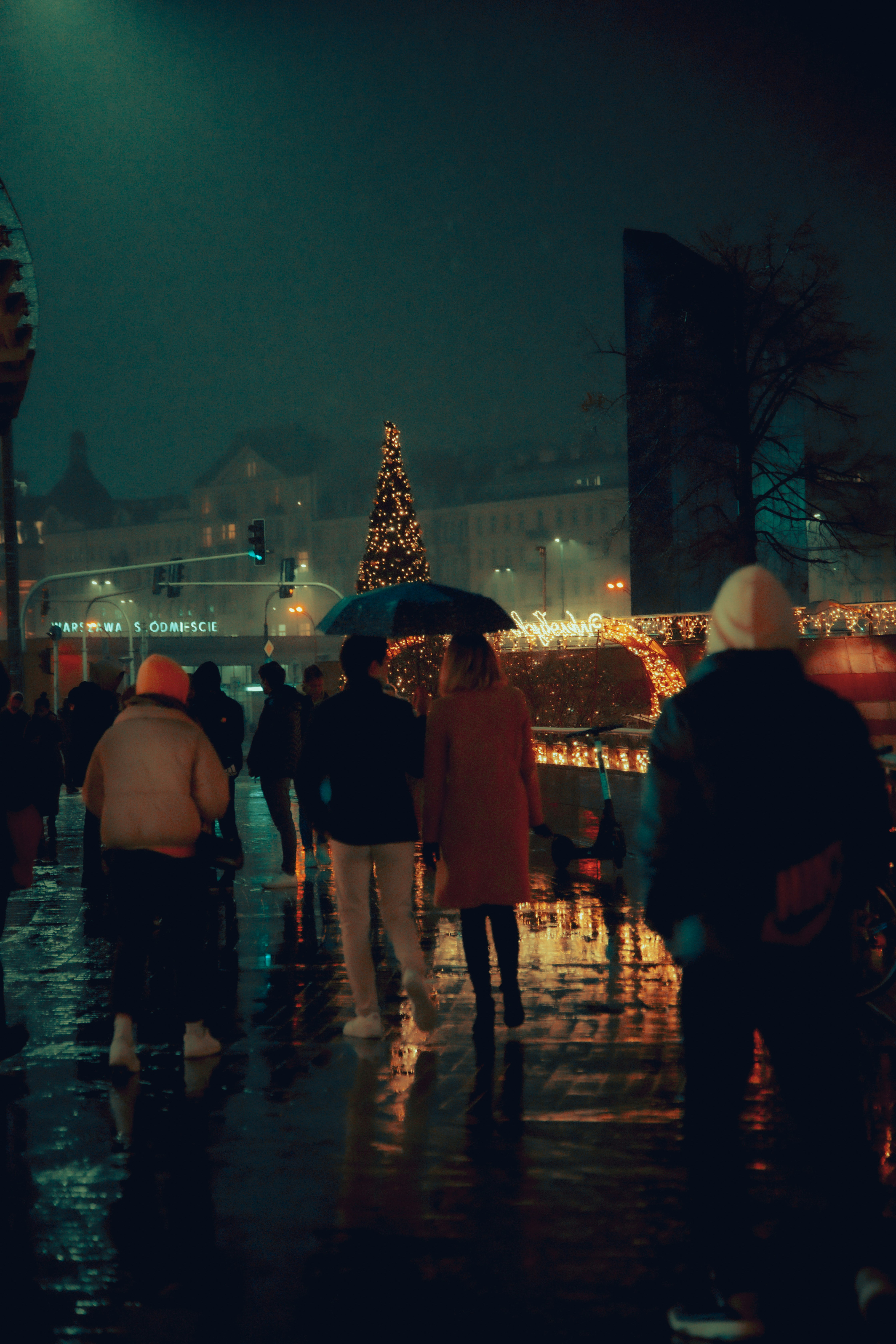 Rain-Kissed Lights: Night in the Christmas Square