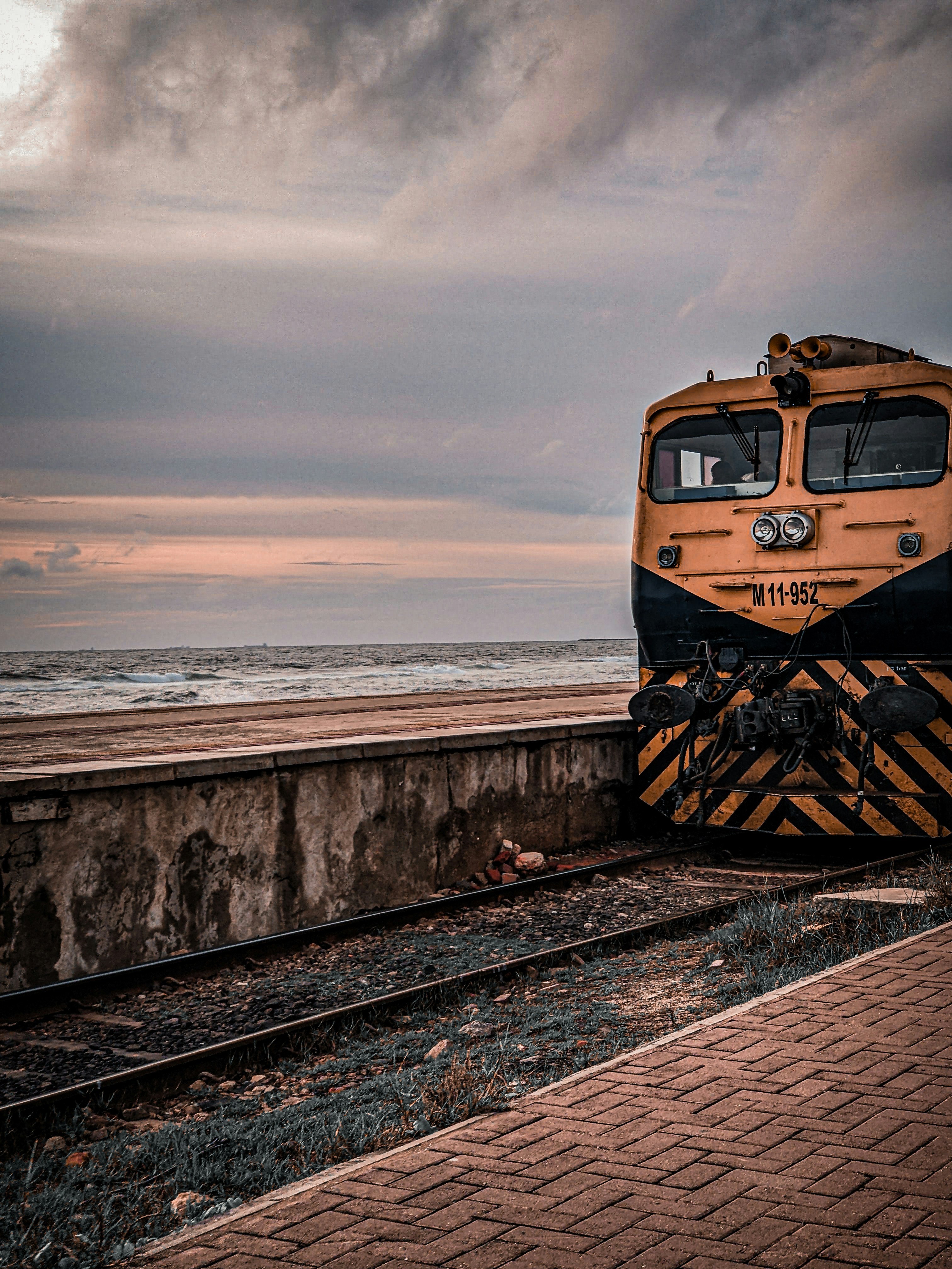 Dusk by the Seaside Rail: A Weathered Locomotive Guards the Pier