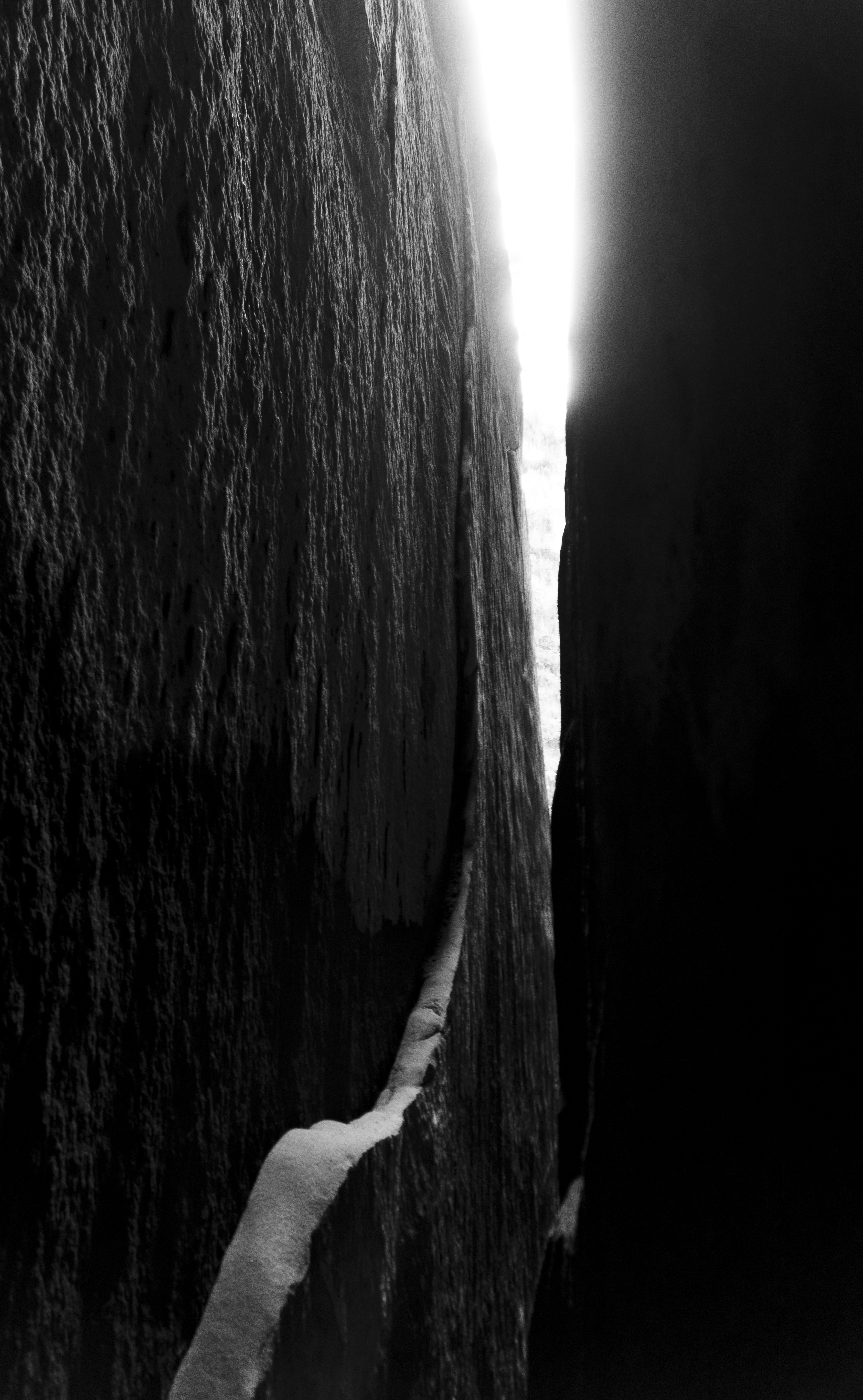 Sliver Between Giants: Light Piercing a Monochrome Canyon