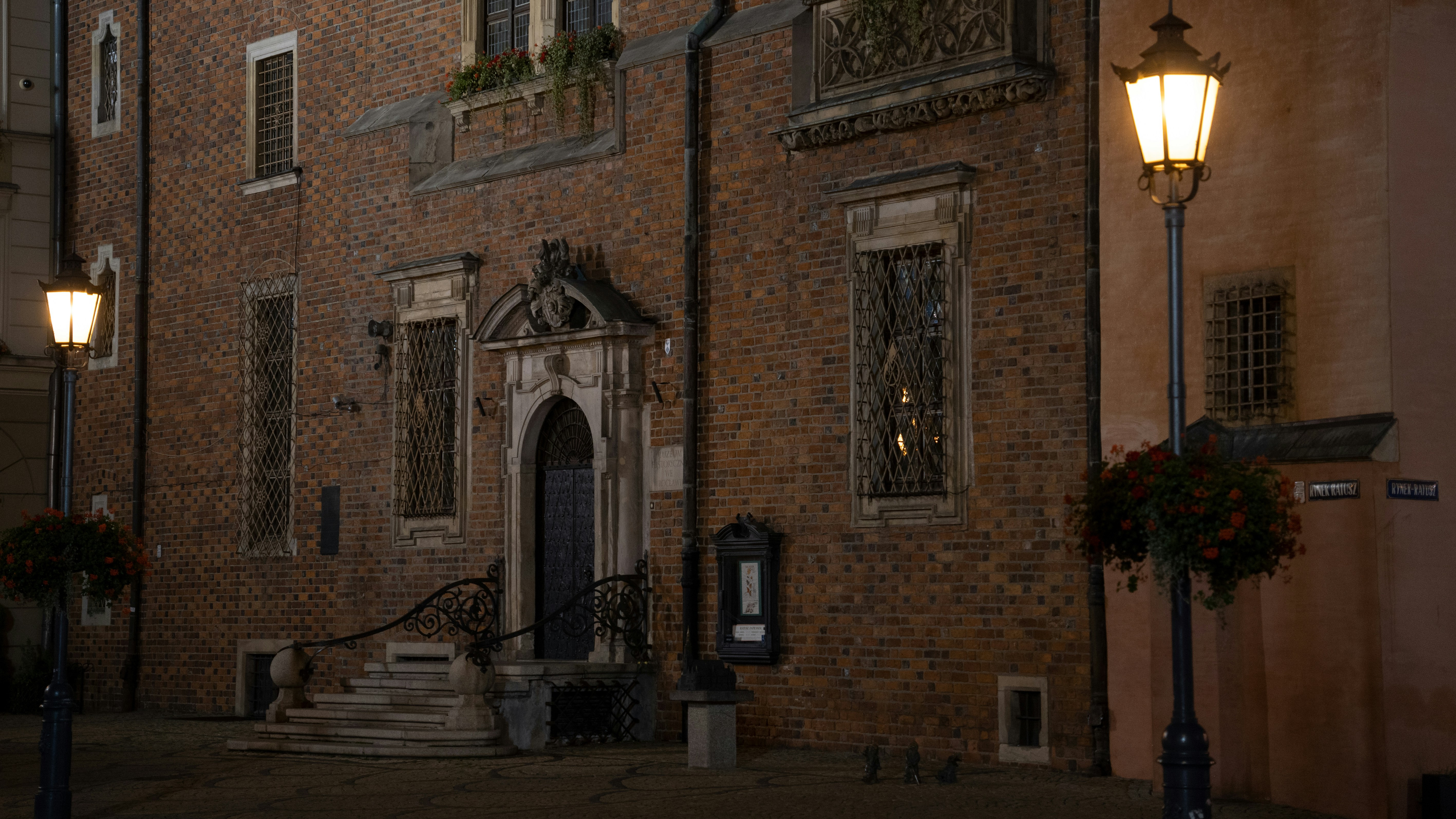 Lantern-lit Entrance on a Brick Townhouse at Night