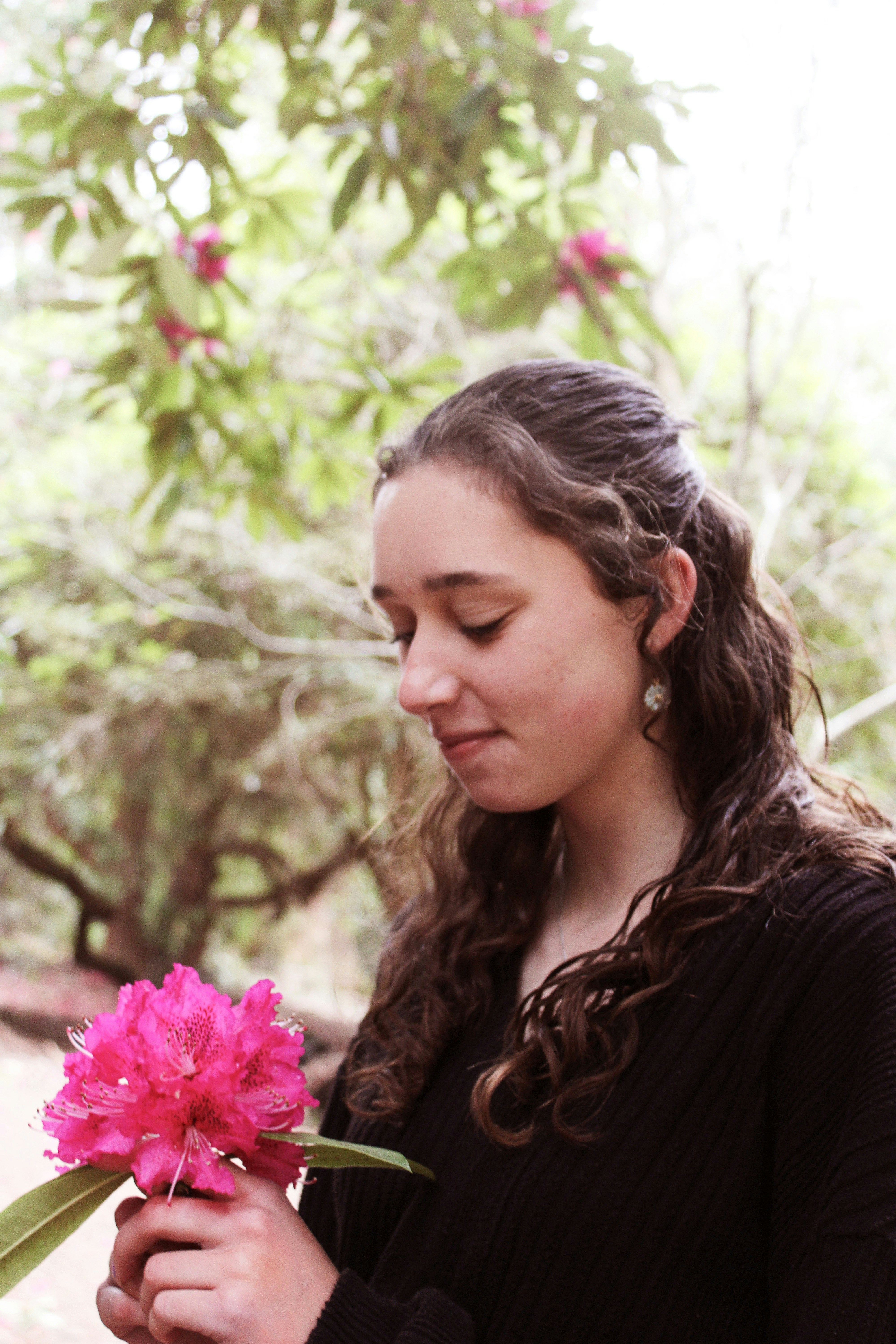 Quiet Reverie Among Pink Blooms: A Portrait in Soft Morning Light