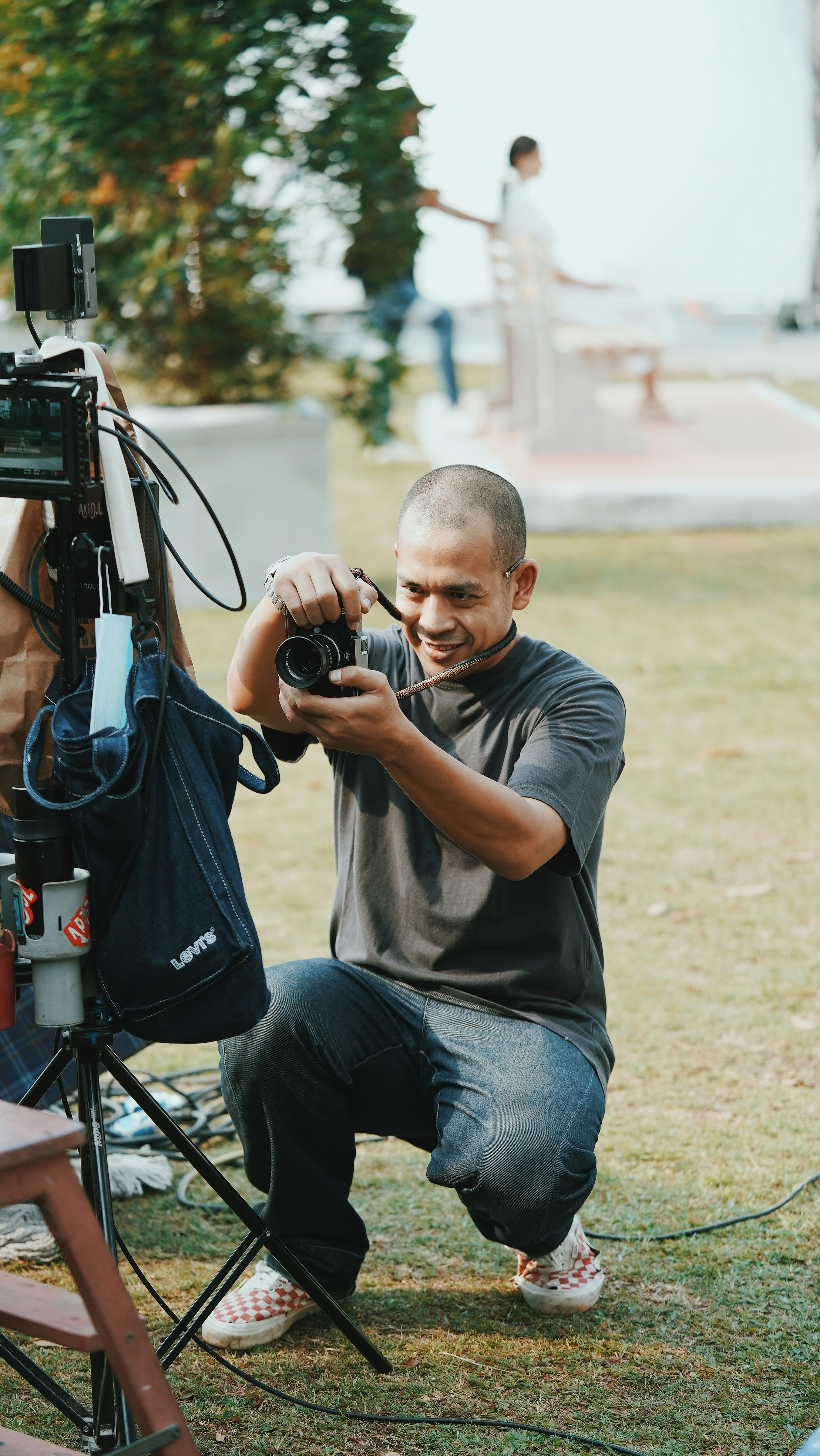 A person kneeling next to a camera photo – Free Human Image on Unsplash