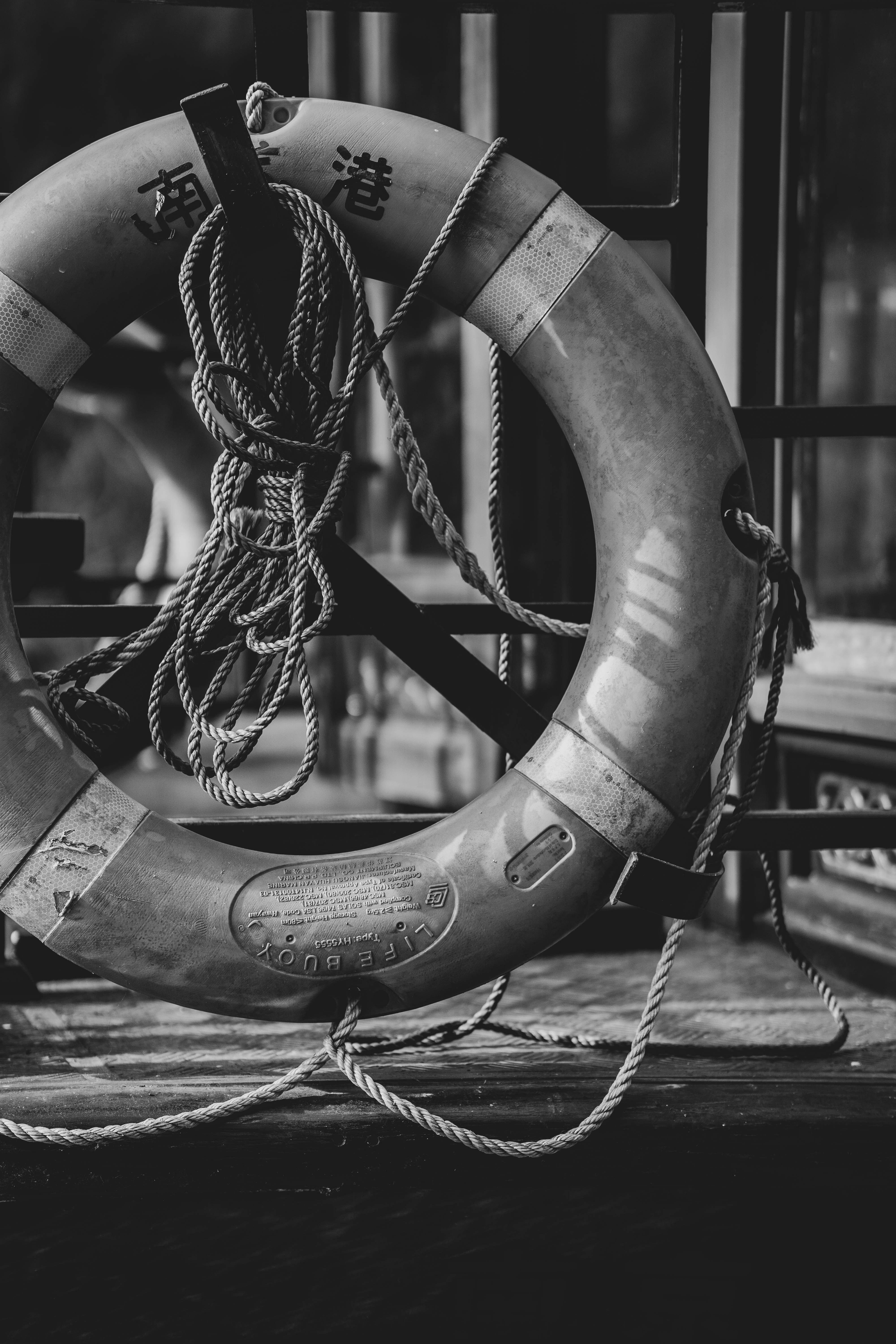 Coiled Rope Encircles a Weathered Lifebuoy on a Quiet Dock