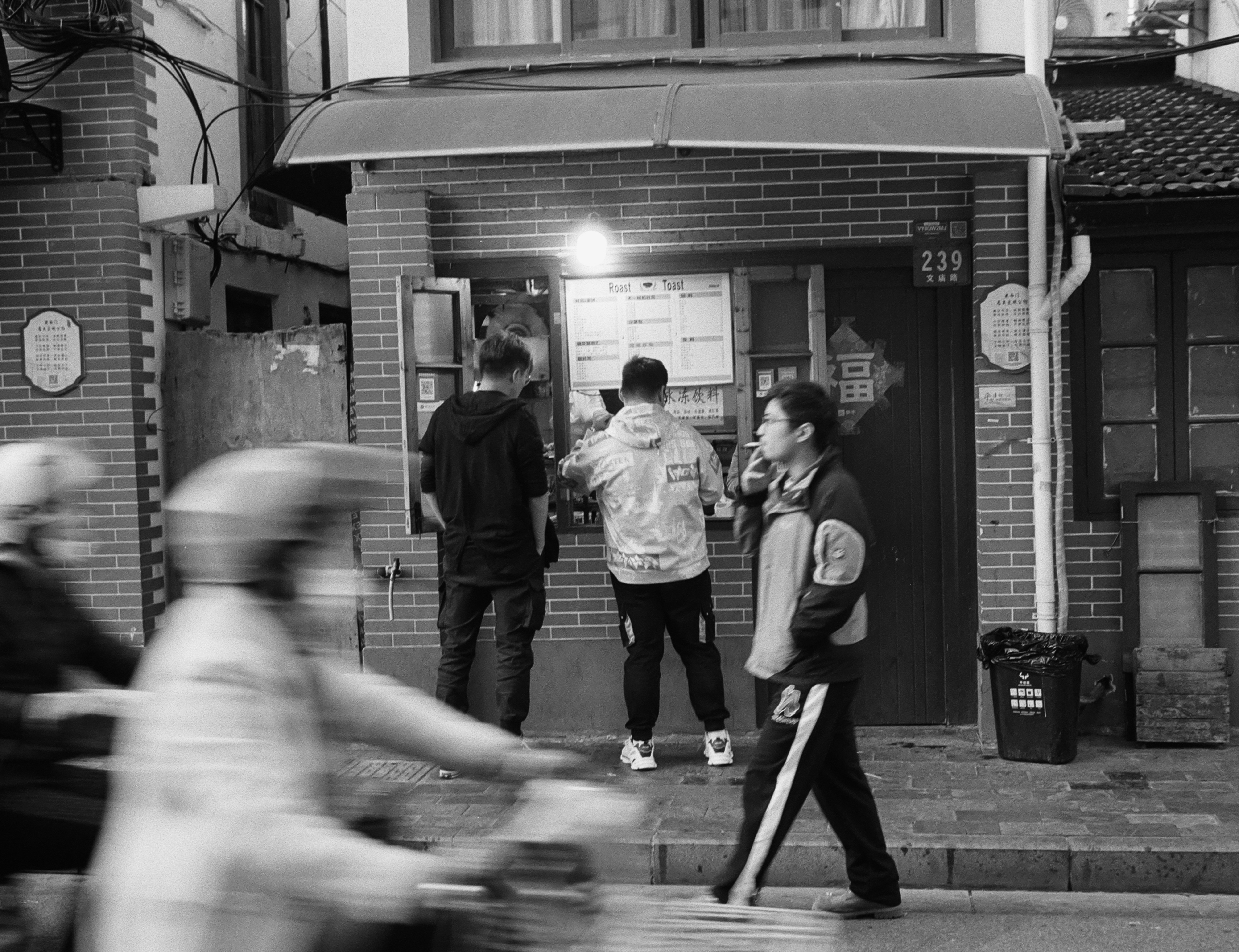 A group of people walking out of a building photo – Free Film Image on ...