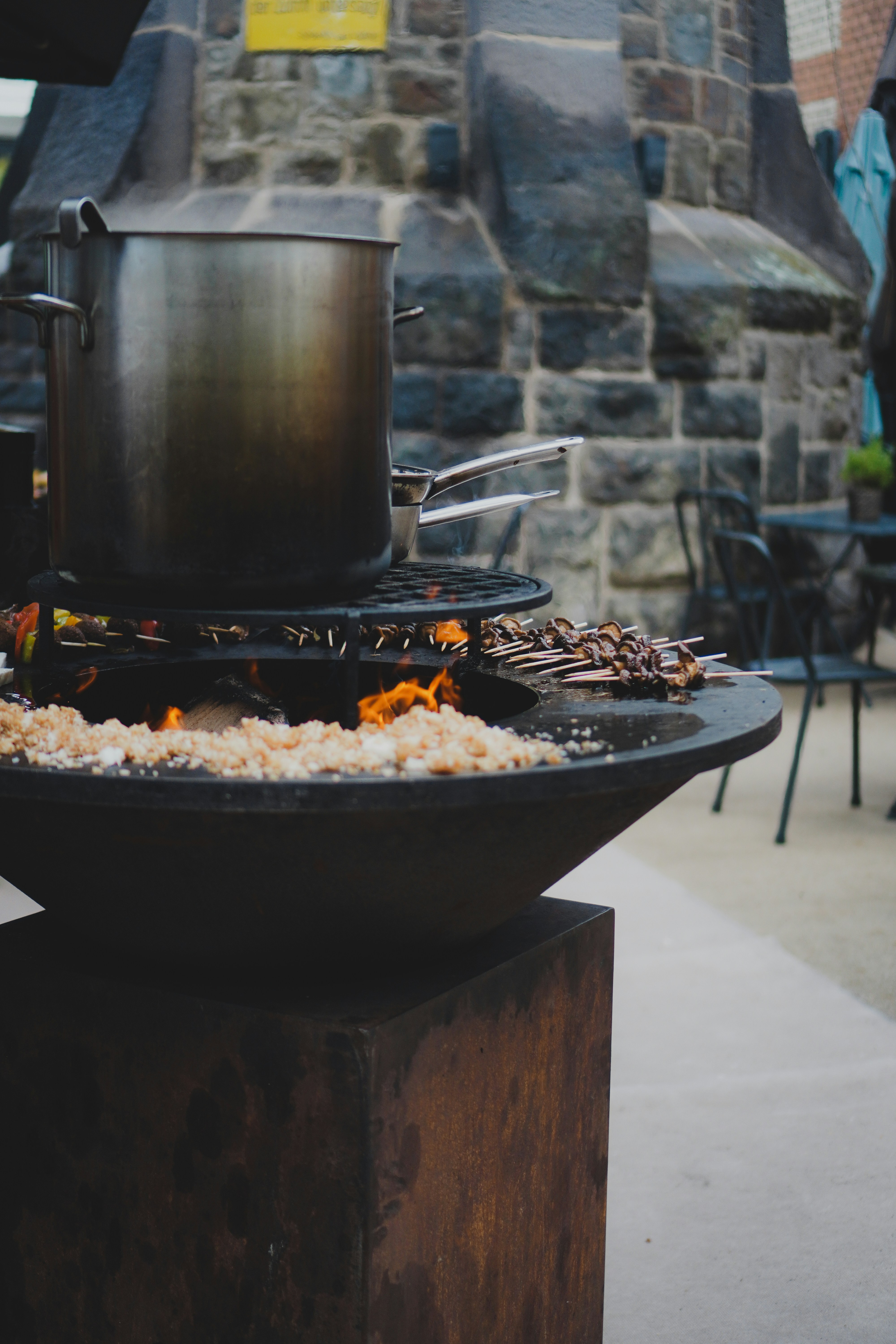 Ember Cast: Pot on the Round Grill in a Stone Courtyard