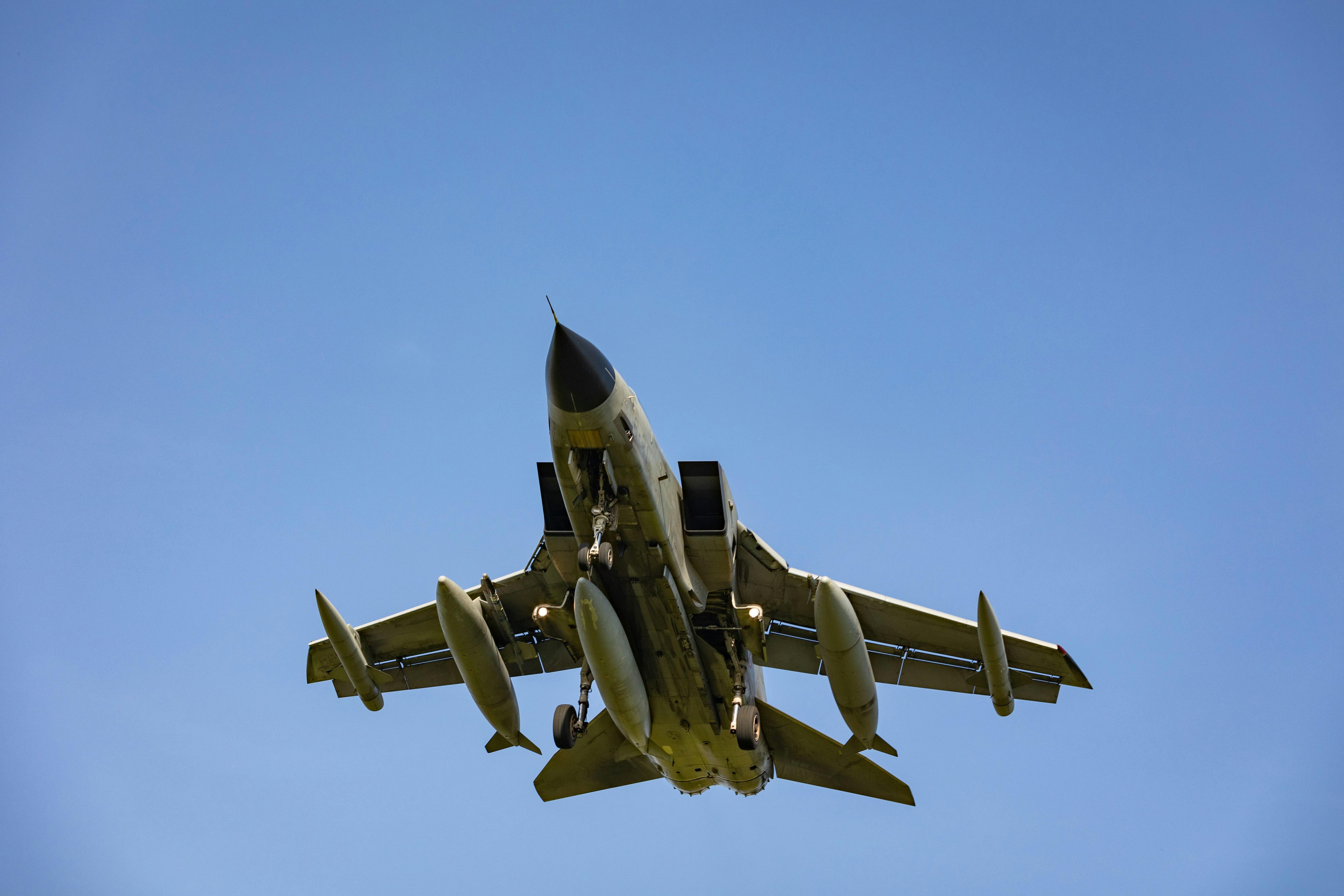 A military jet flying in the sky photo – Free Volkel Image on Unsplash