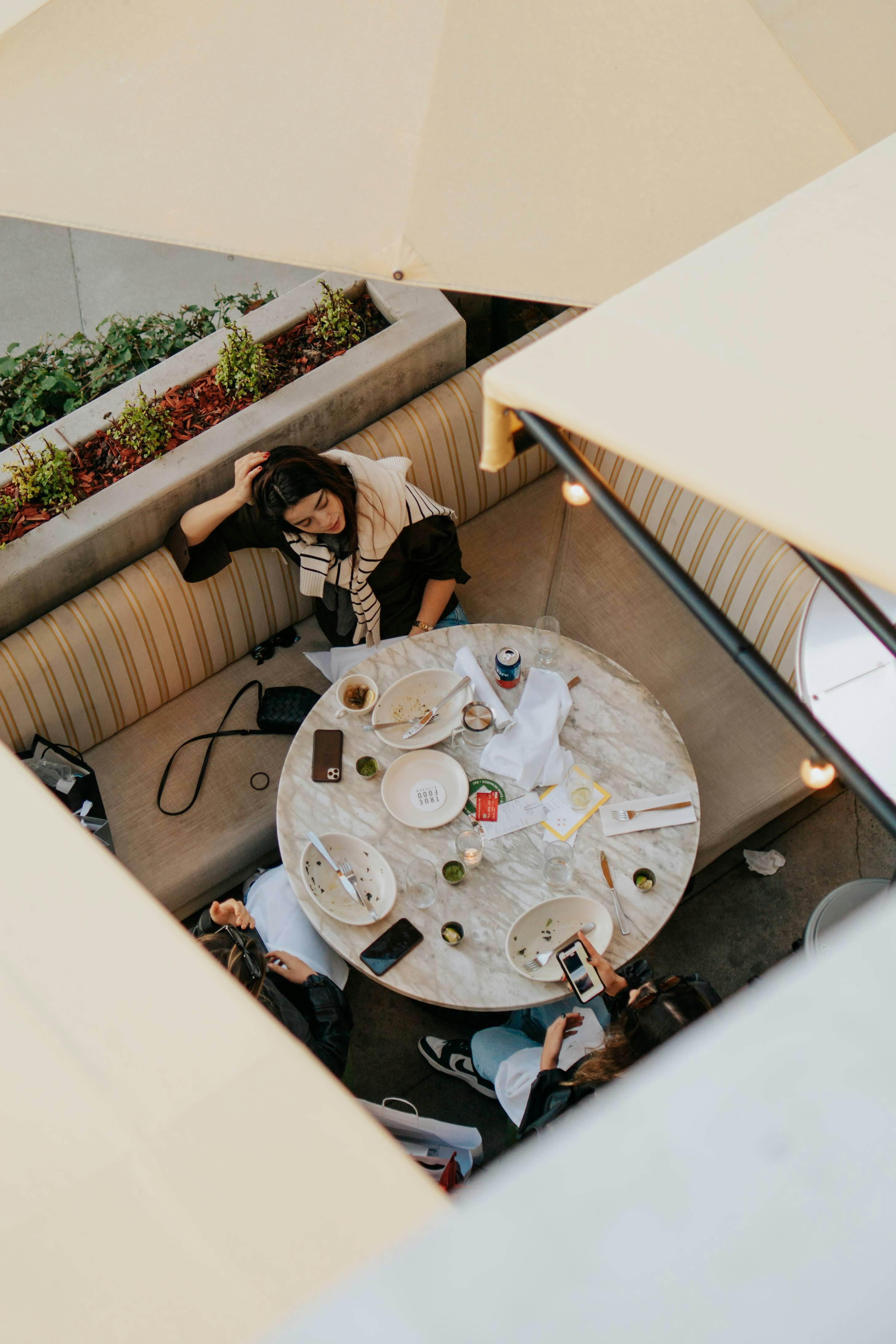 A person sitting at a table with a plate of food photo – Free Person ...