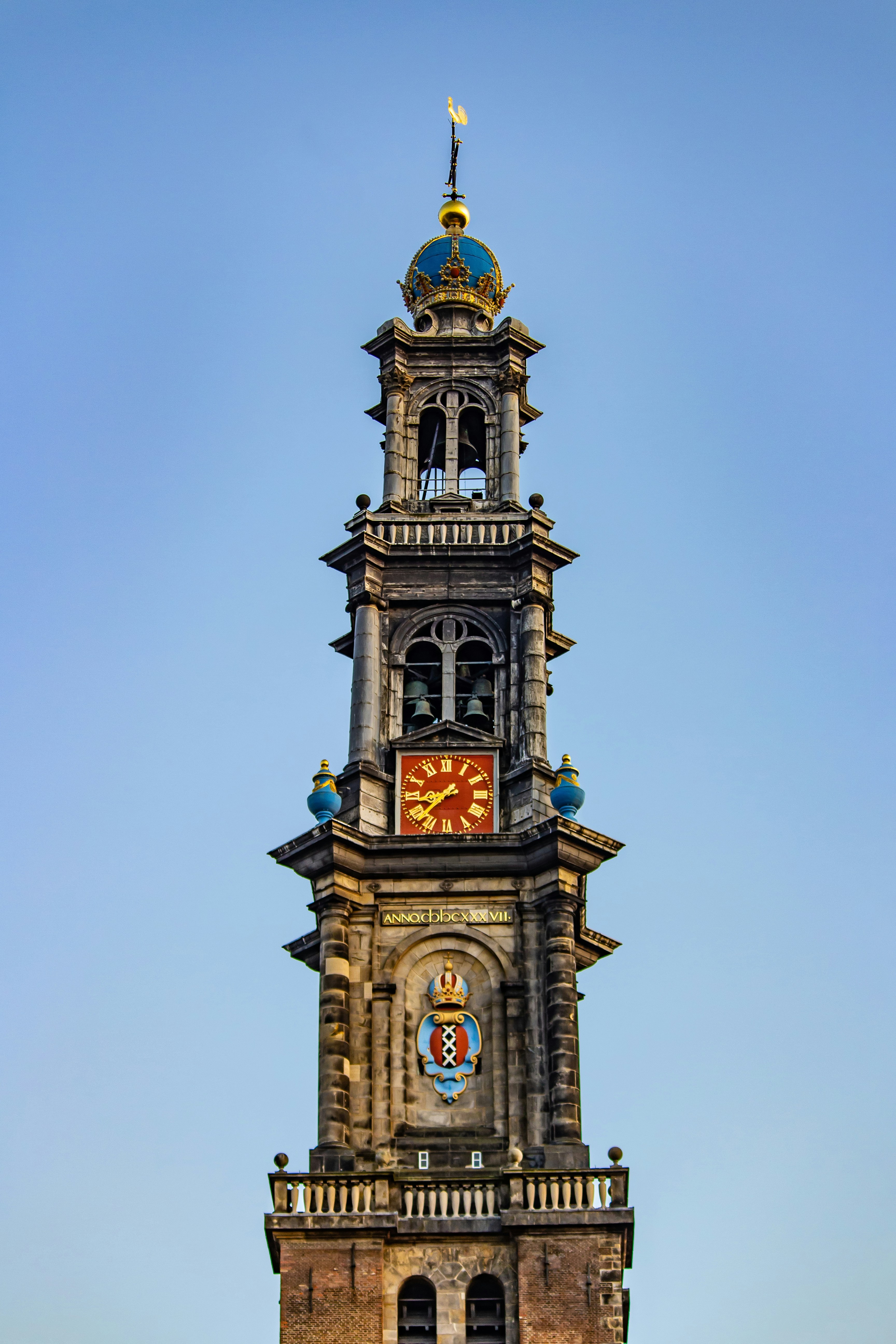 Crimson Clock Dial Under a Cerulean Crown on a Stone Tower
