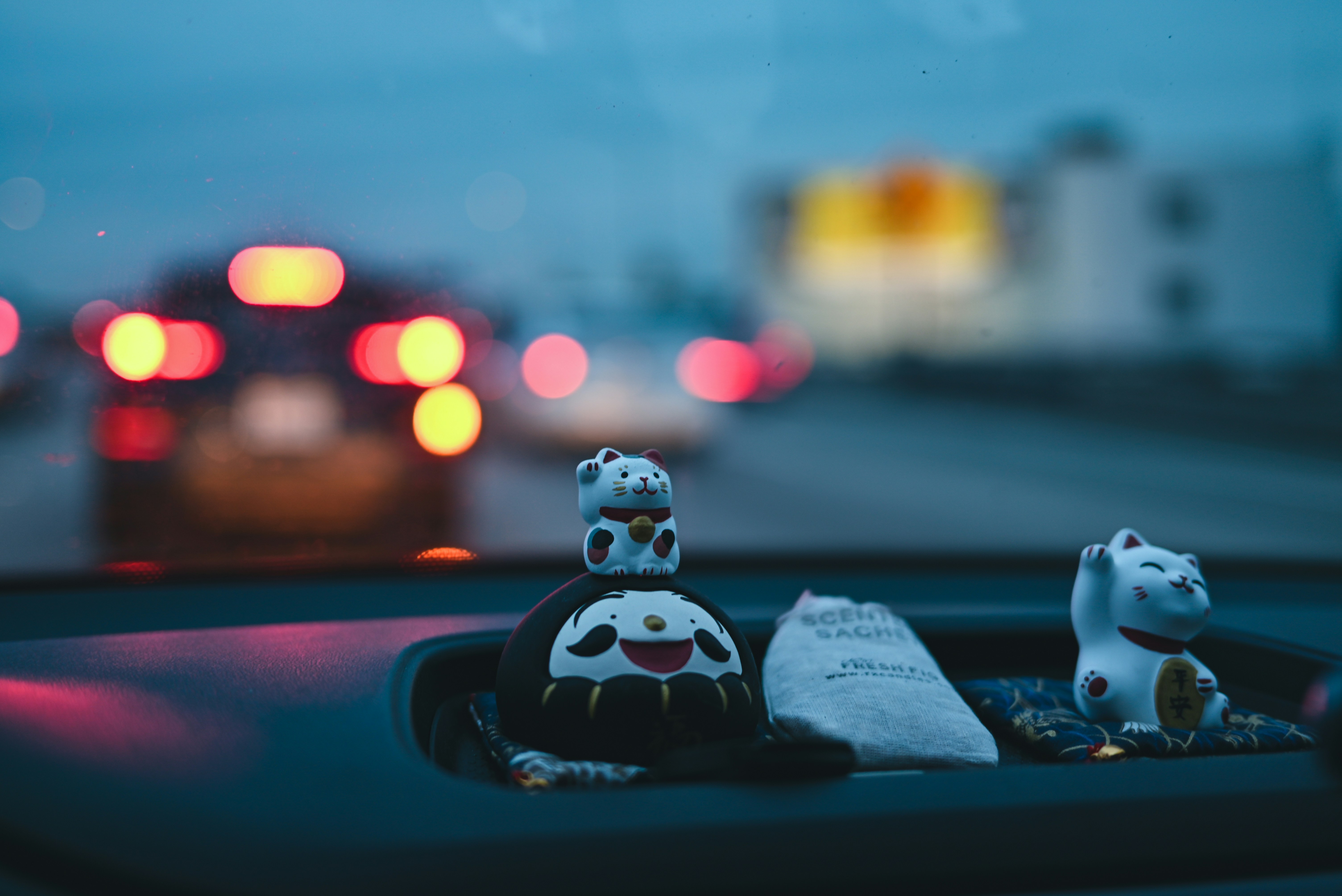 Night-Glow Guardians: Trio of Toy Cat Figurines in Soft Focus