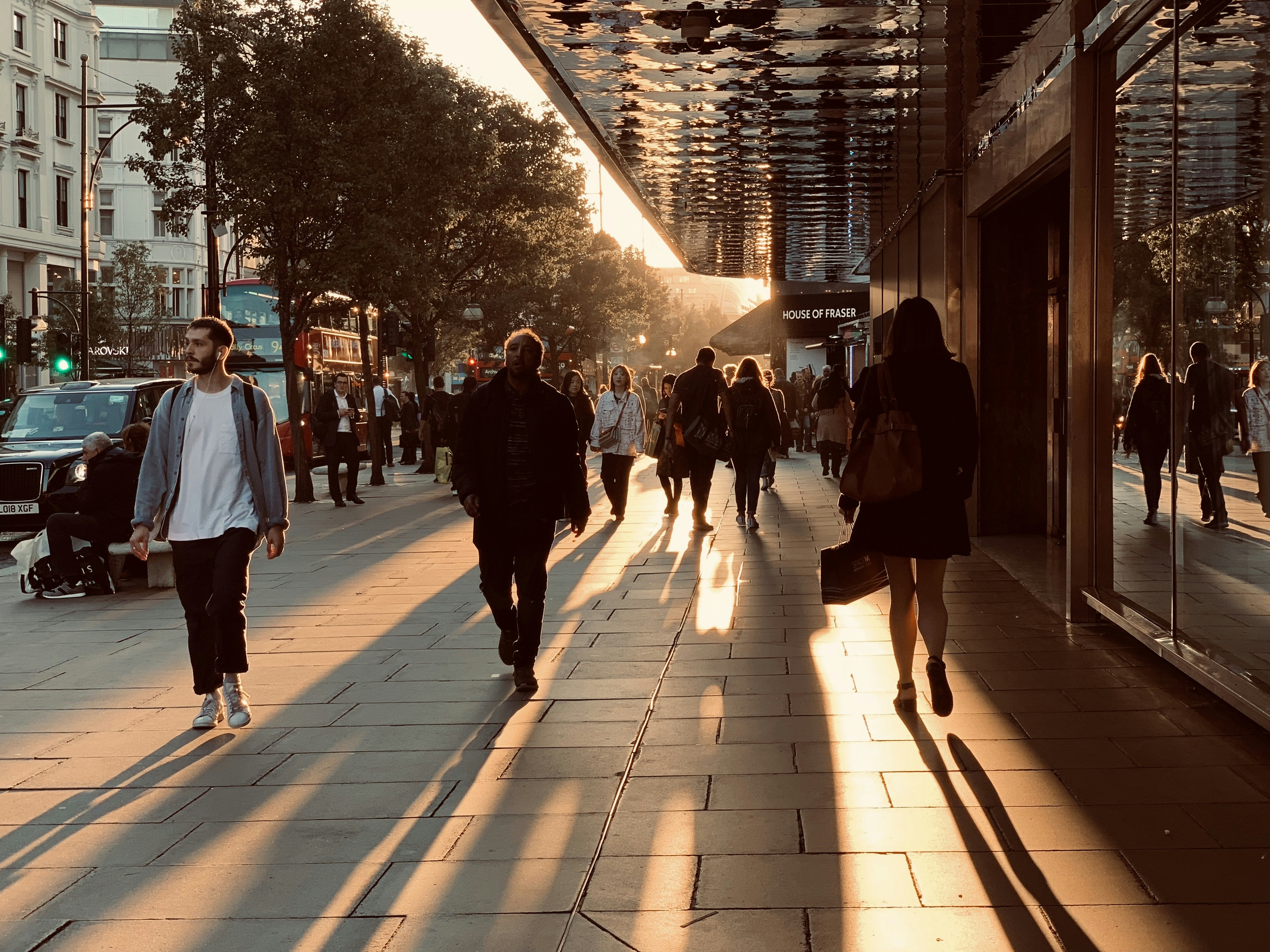 people walking on a sidewalk