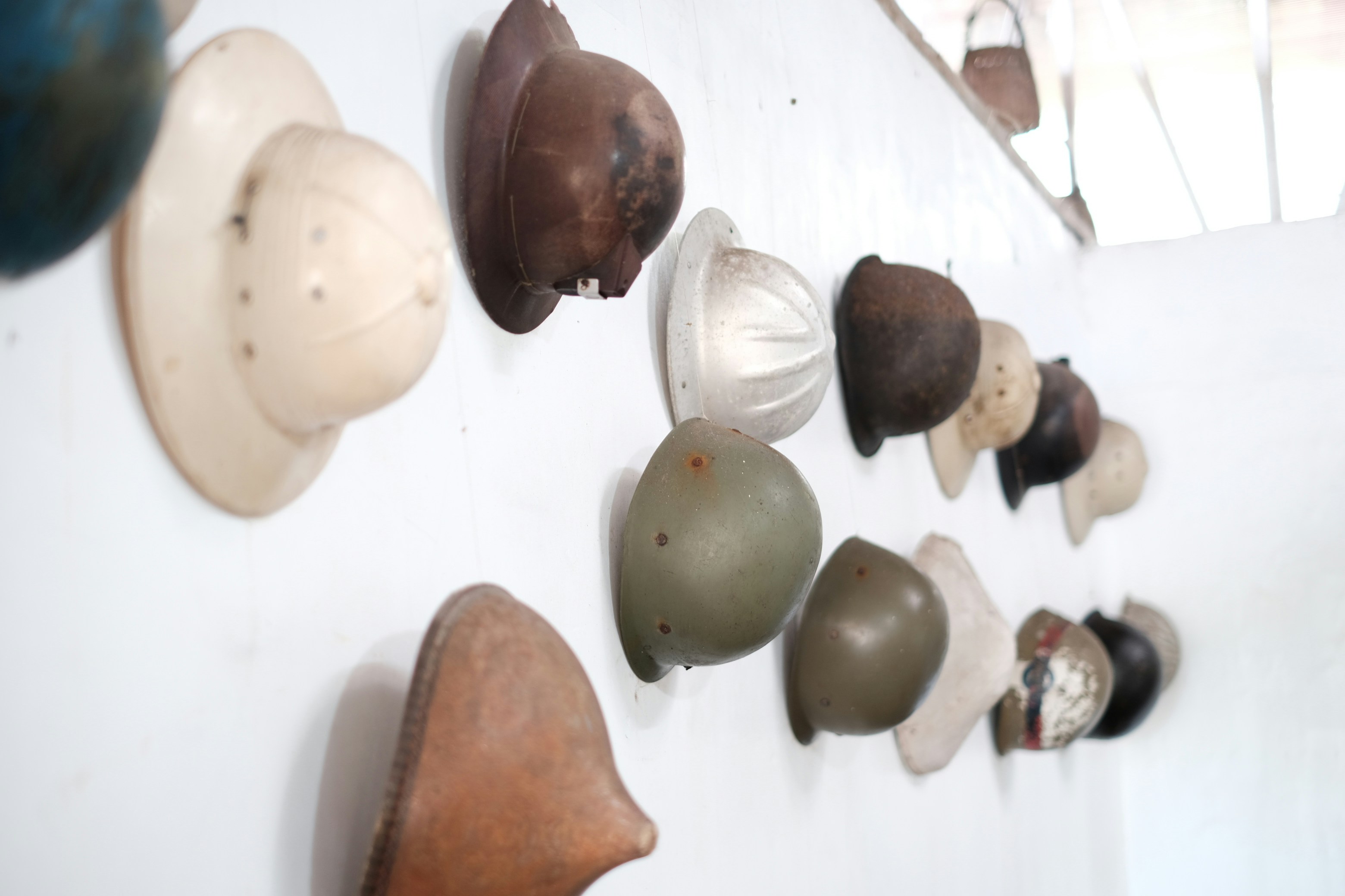 Muted Spherical Relics: Ceramic Domes on a White Gallery Wall