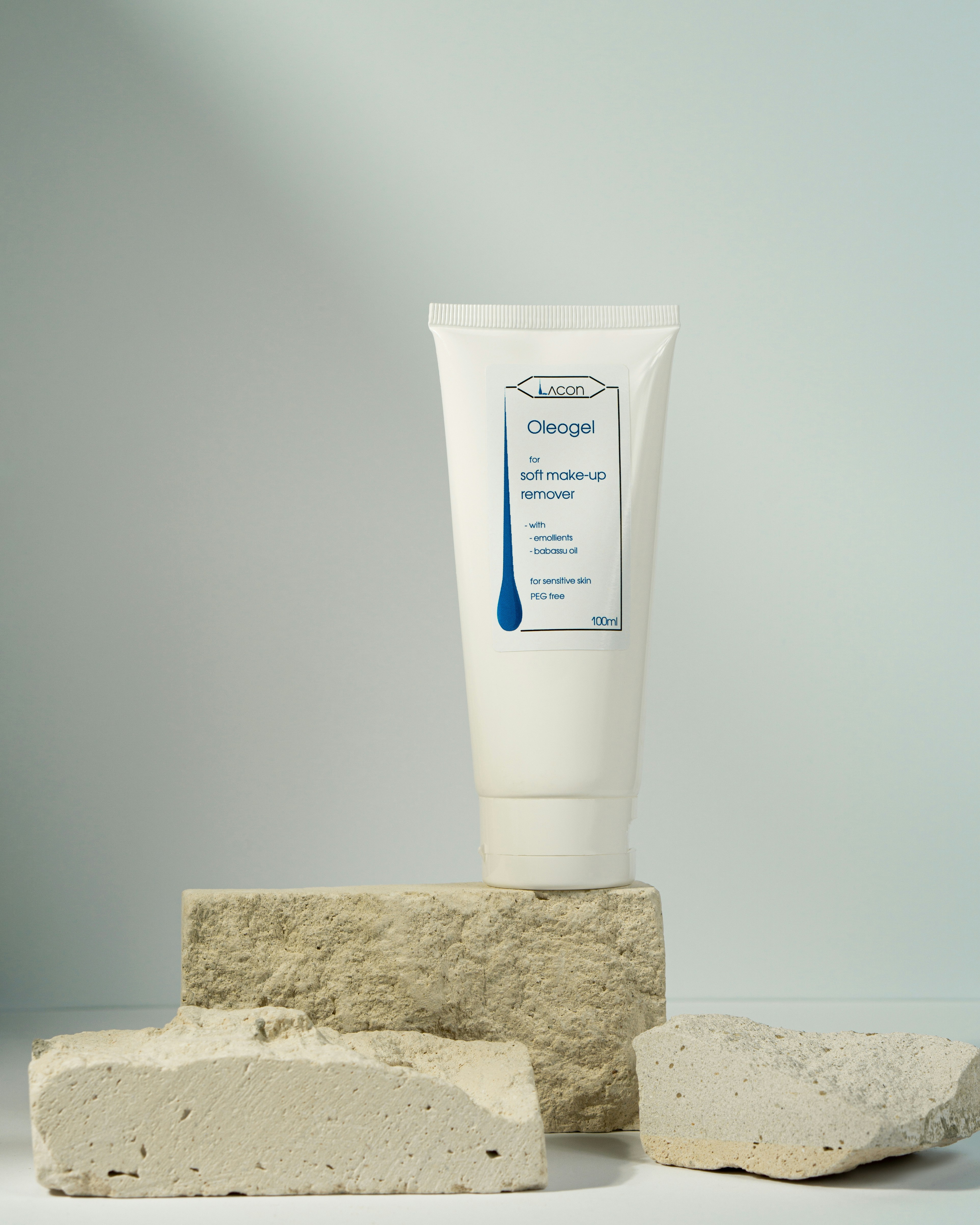 A white cylindrical object with a blue label on a stack of rocks photo ...