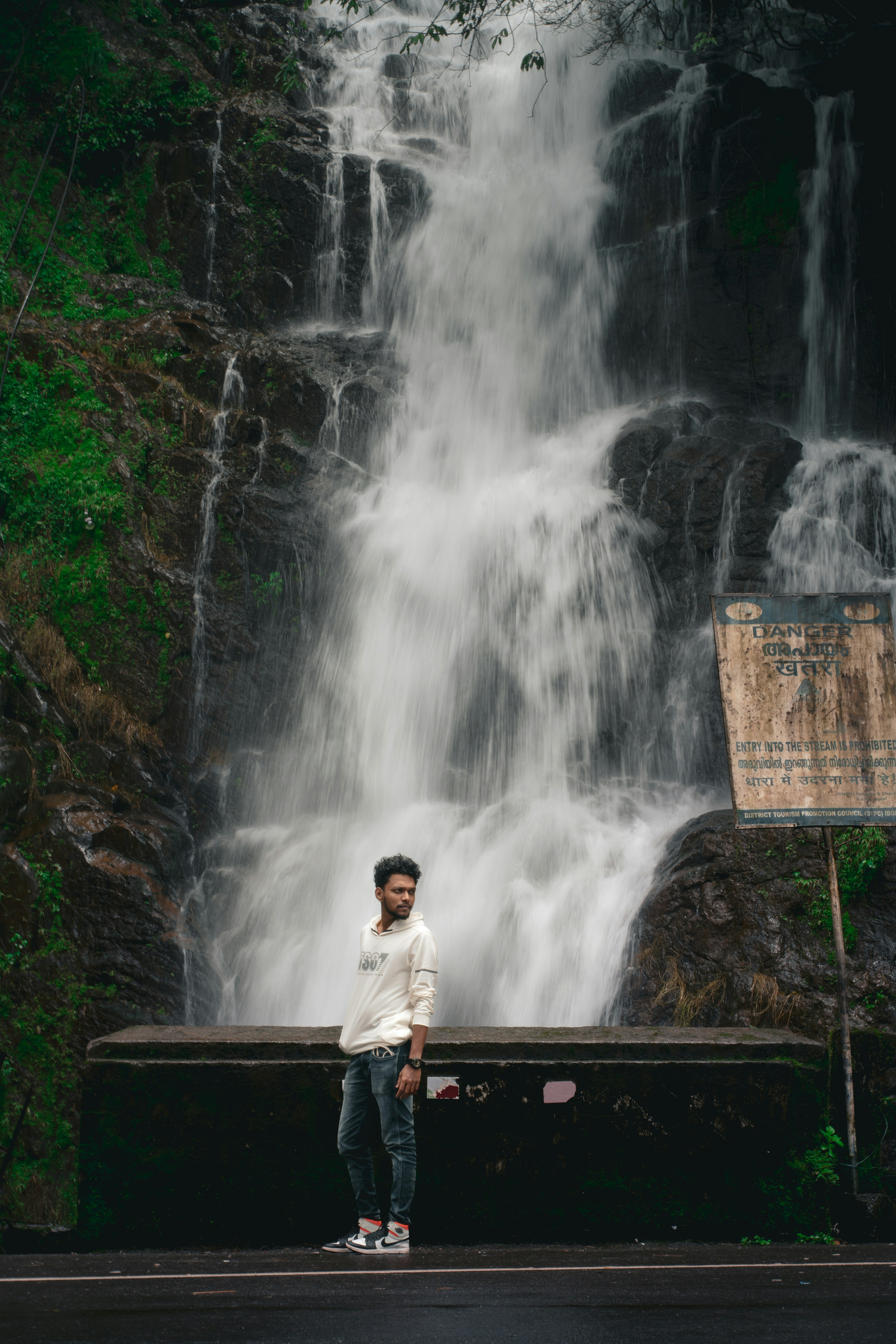 A person standing in front of a waterfall photo – Free Water Image on ...