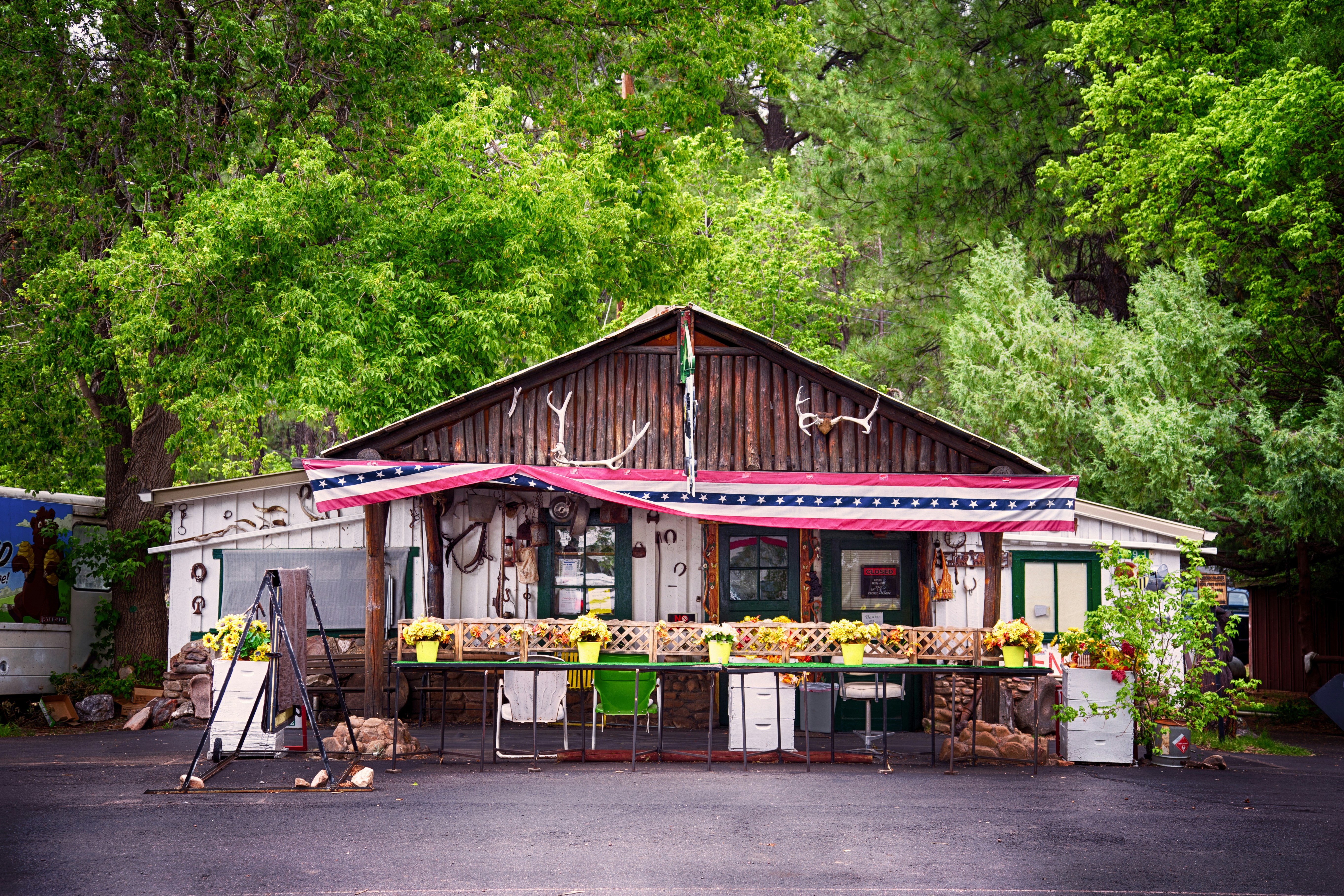 Verdant Frontier Market: A Rustic Stall Draped in Flags and Flowers