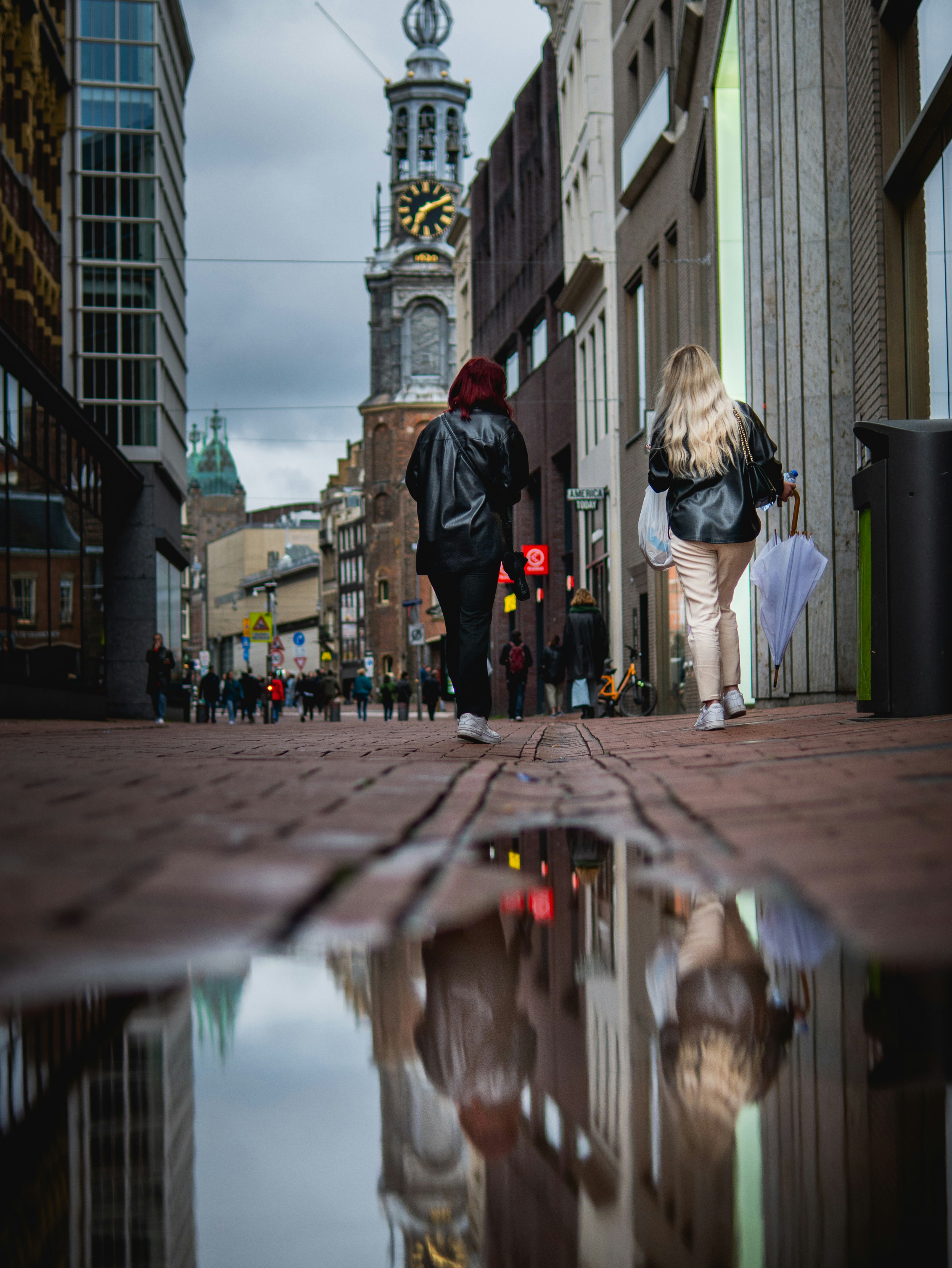 a man and woman walking down a sidewalk