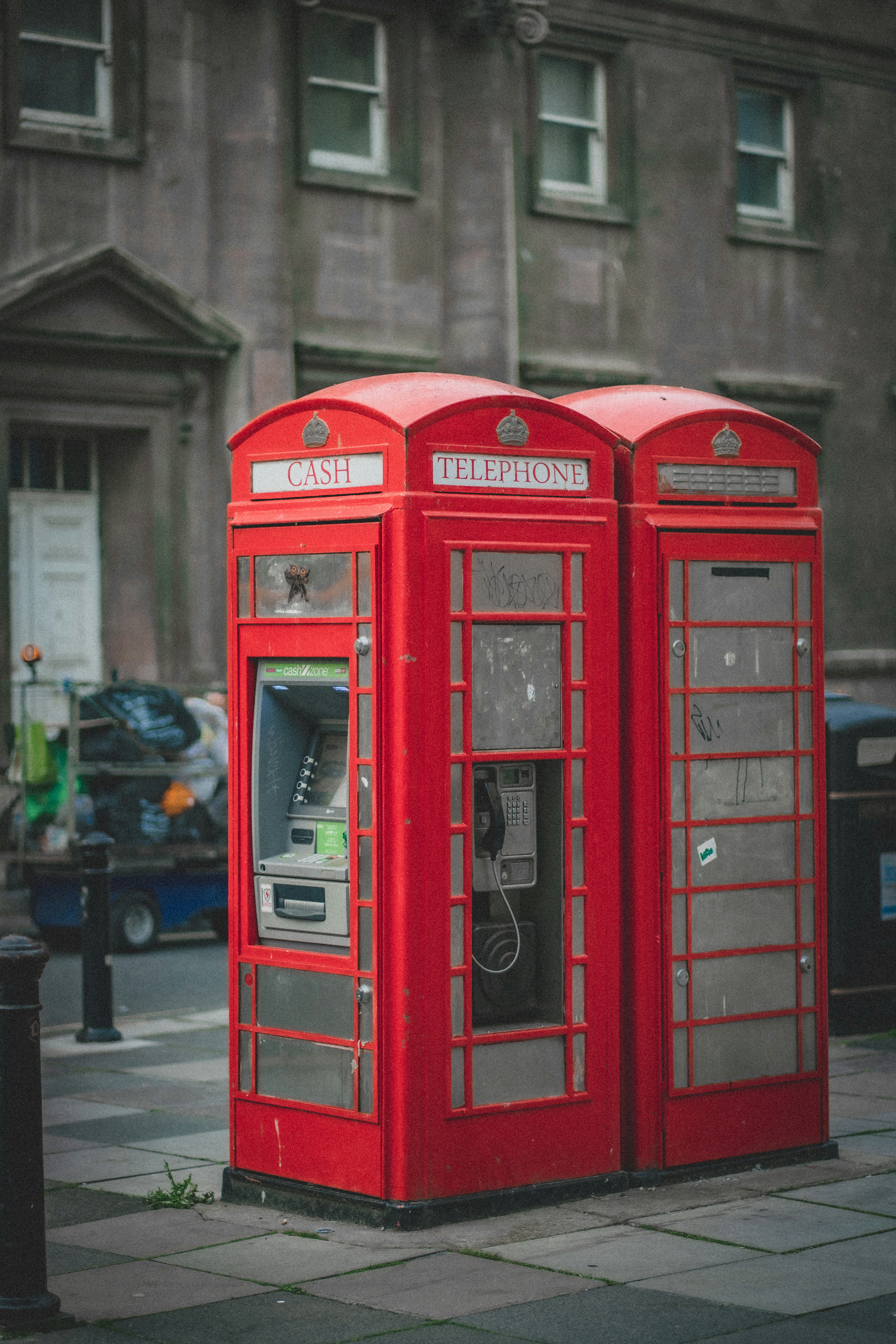 A red telephone booth on a sidewalk photo – Free Uk Image on Unsplash