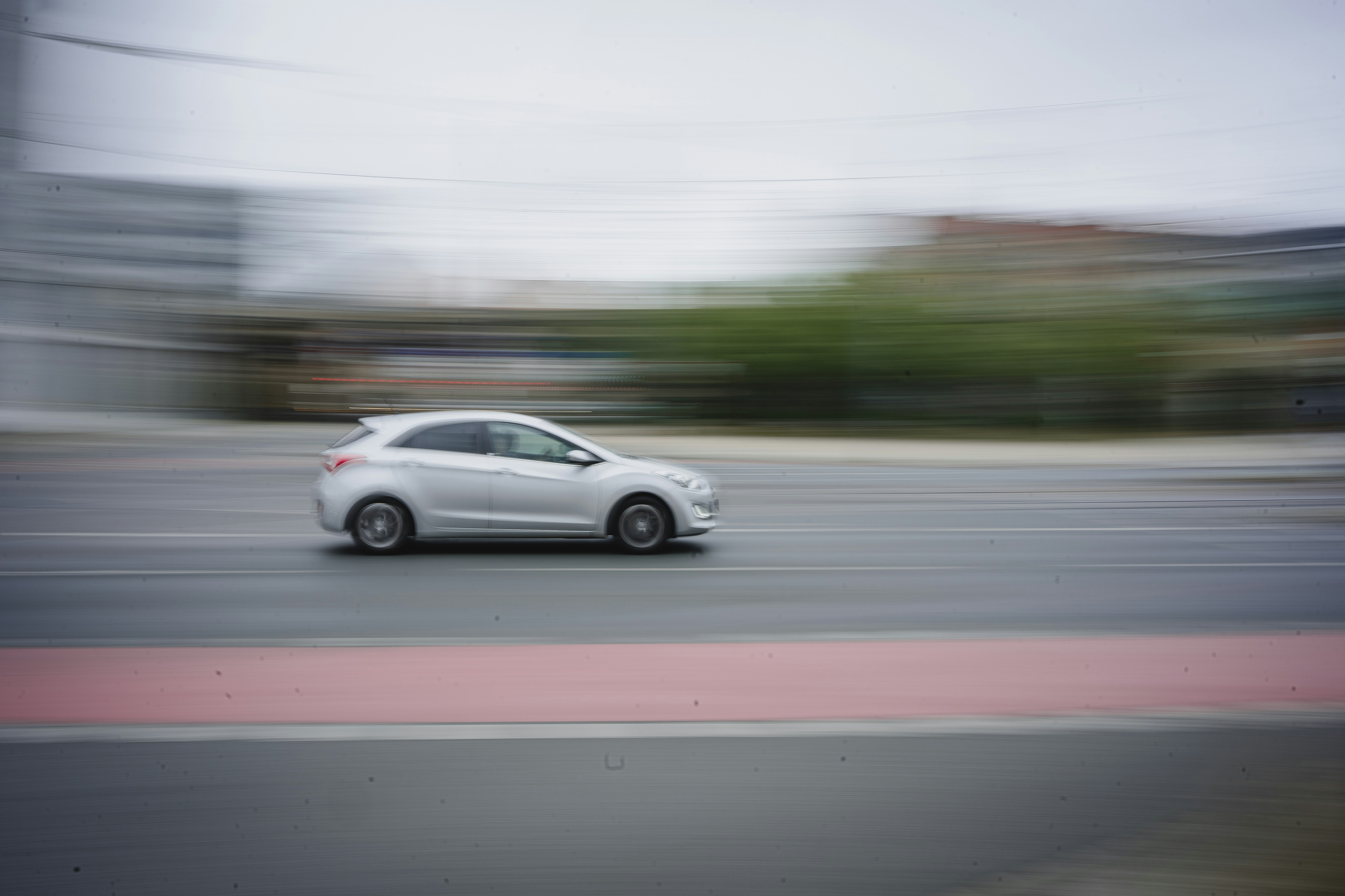 A car driving on a road photo – Free Grey Image on Unsplash