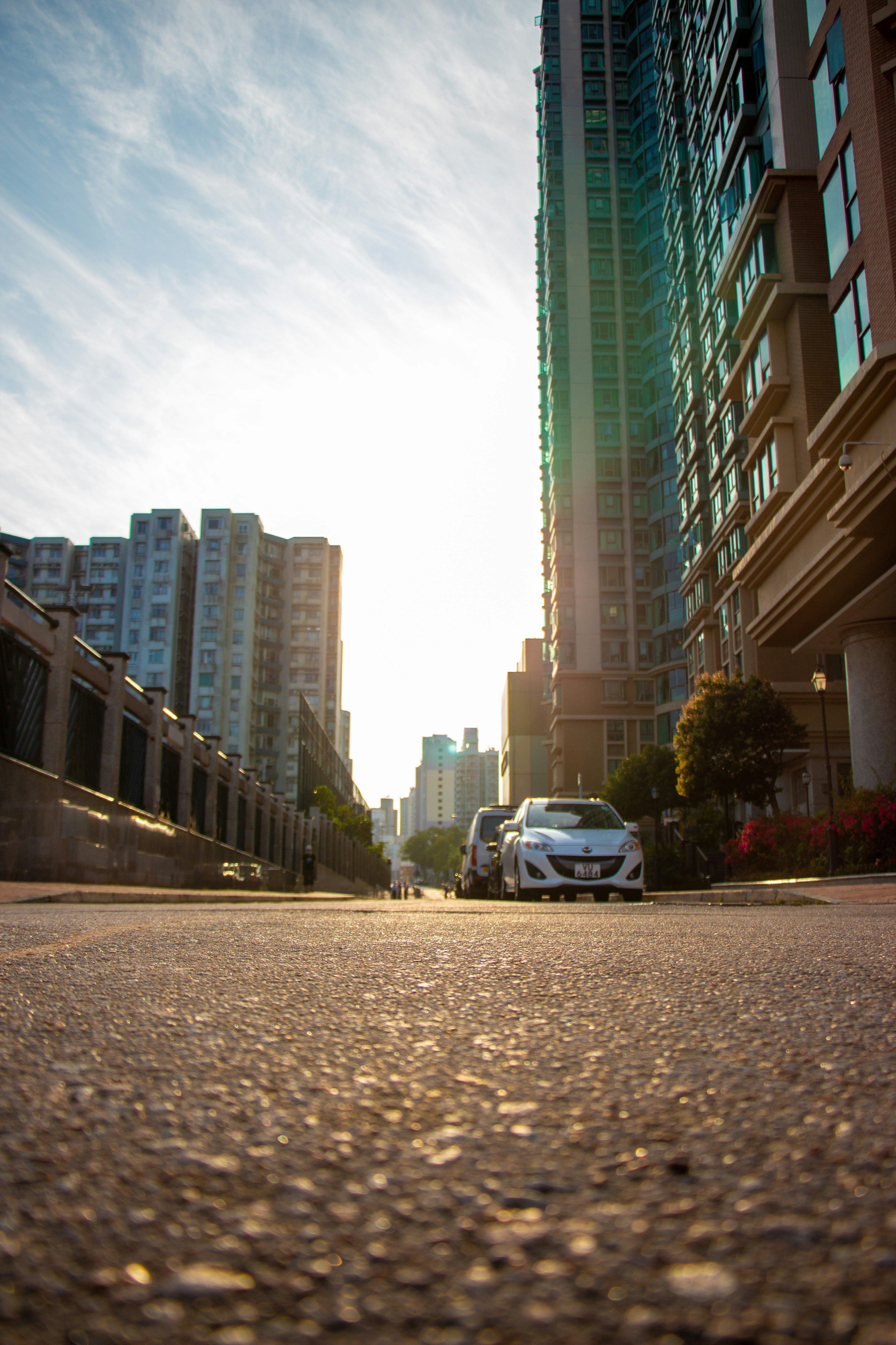 A car parked on a street between buildings photo – Free Hong kong Image ...